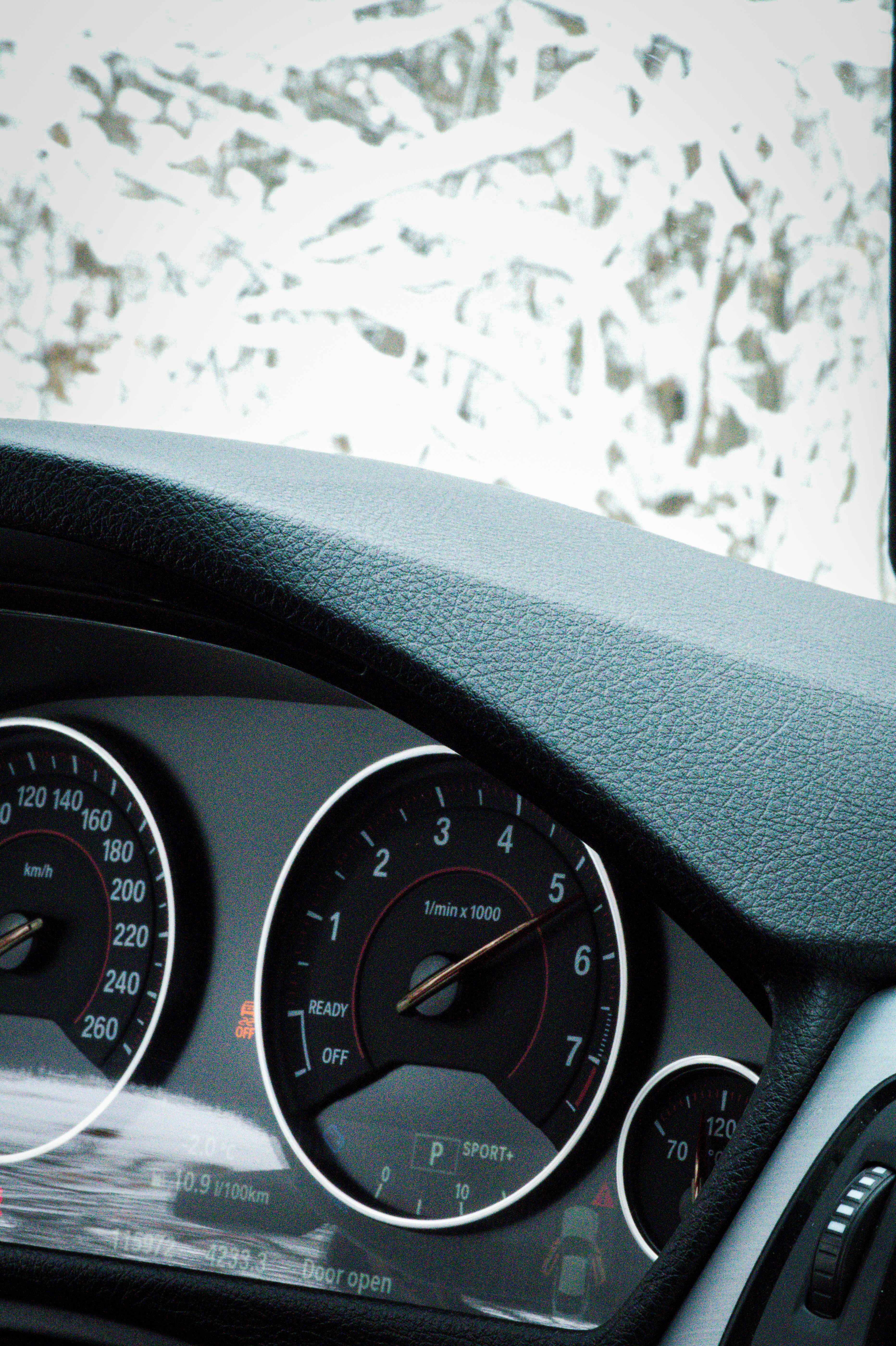 RPM Pulse: Close-Up of a Car's Instrument Cluster Framed by Frosted Glass