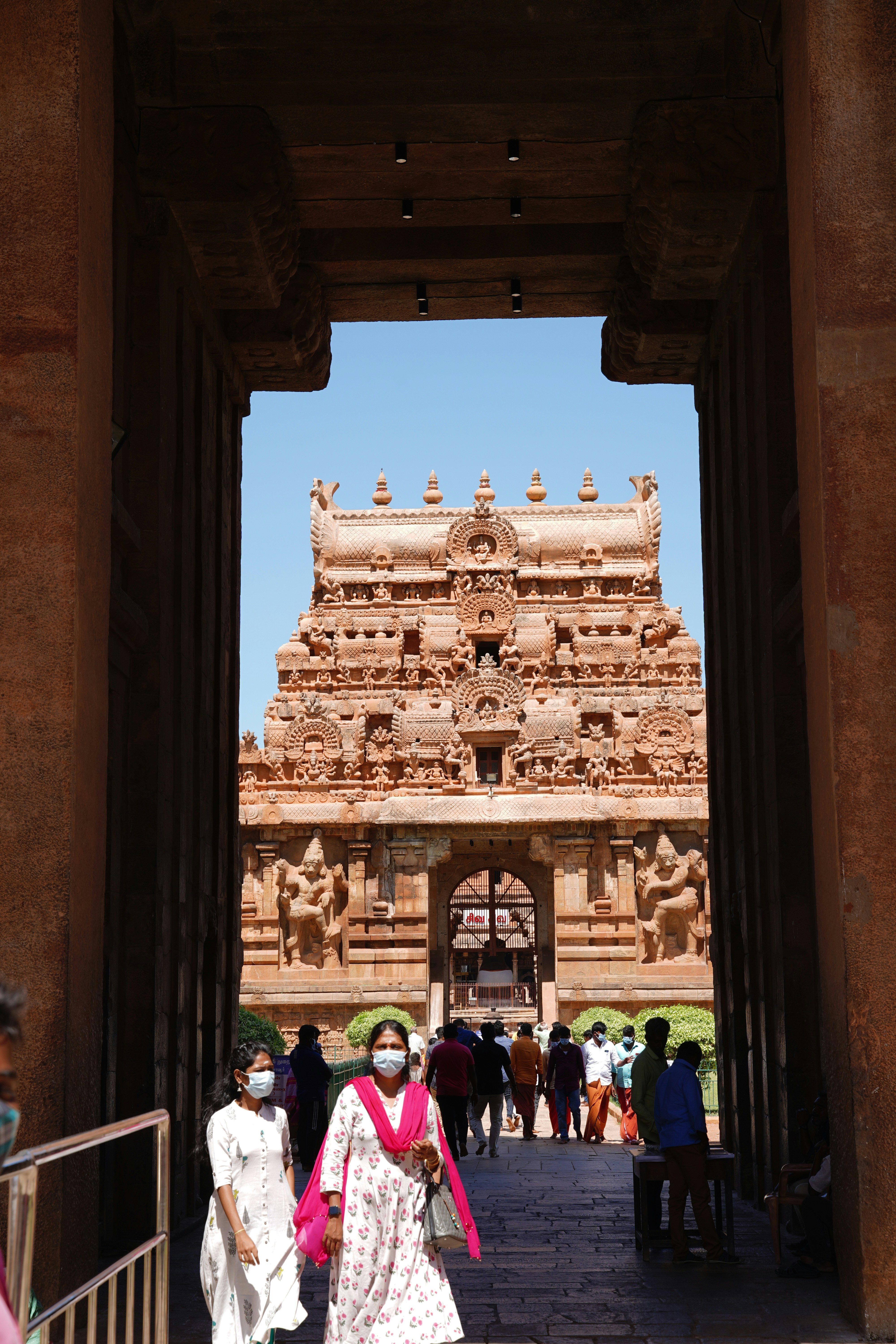 Through the Gate: Sunlit Gopuram Rising Beyond an Ancient Arch