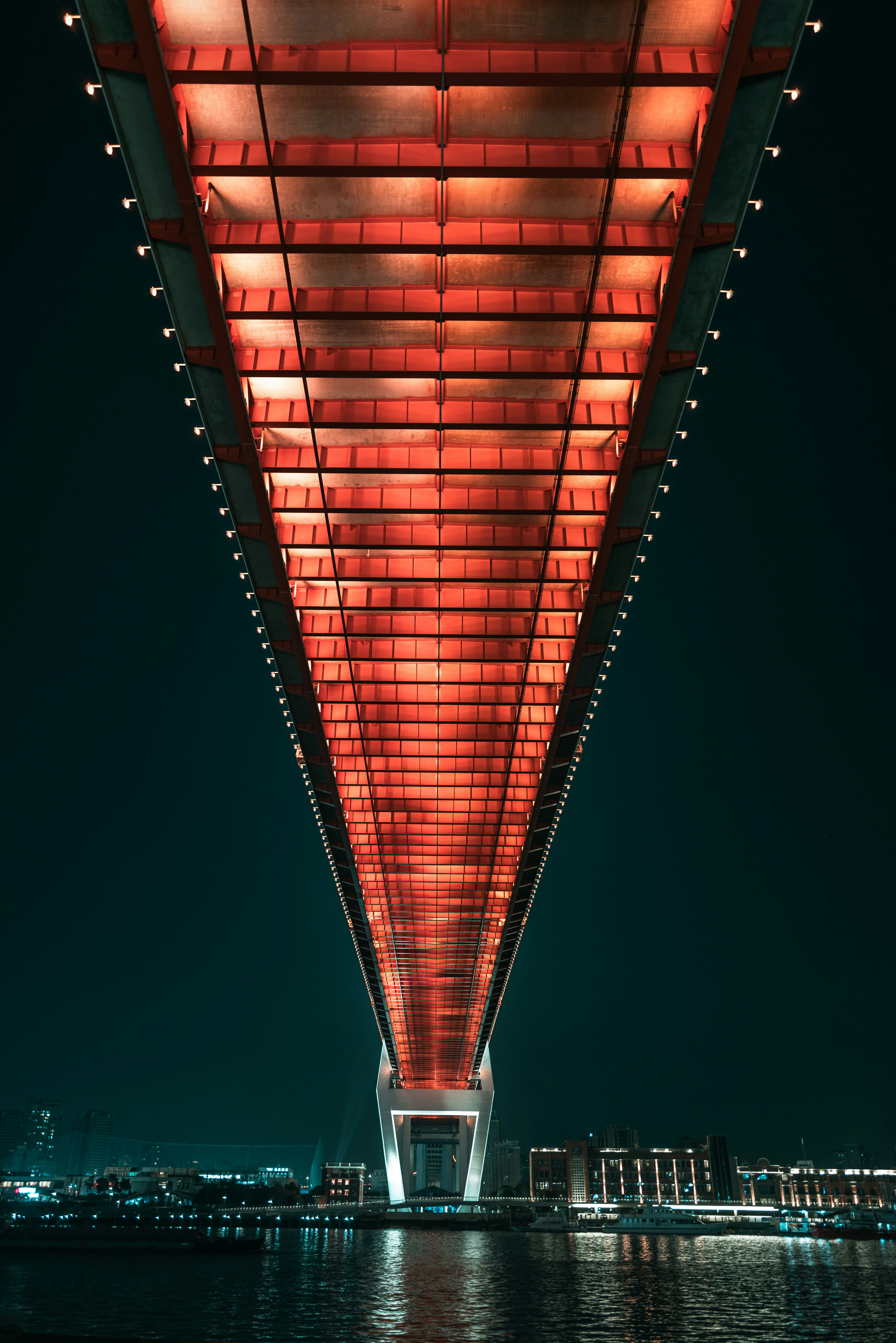 The underside of a bridge lit up at night photo – Free City Image on ...