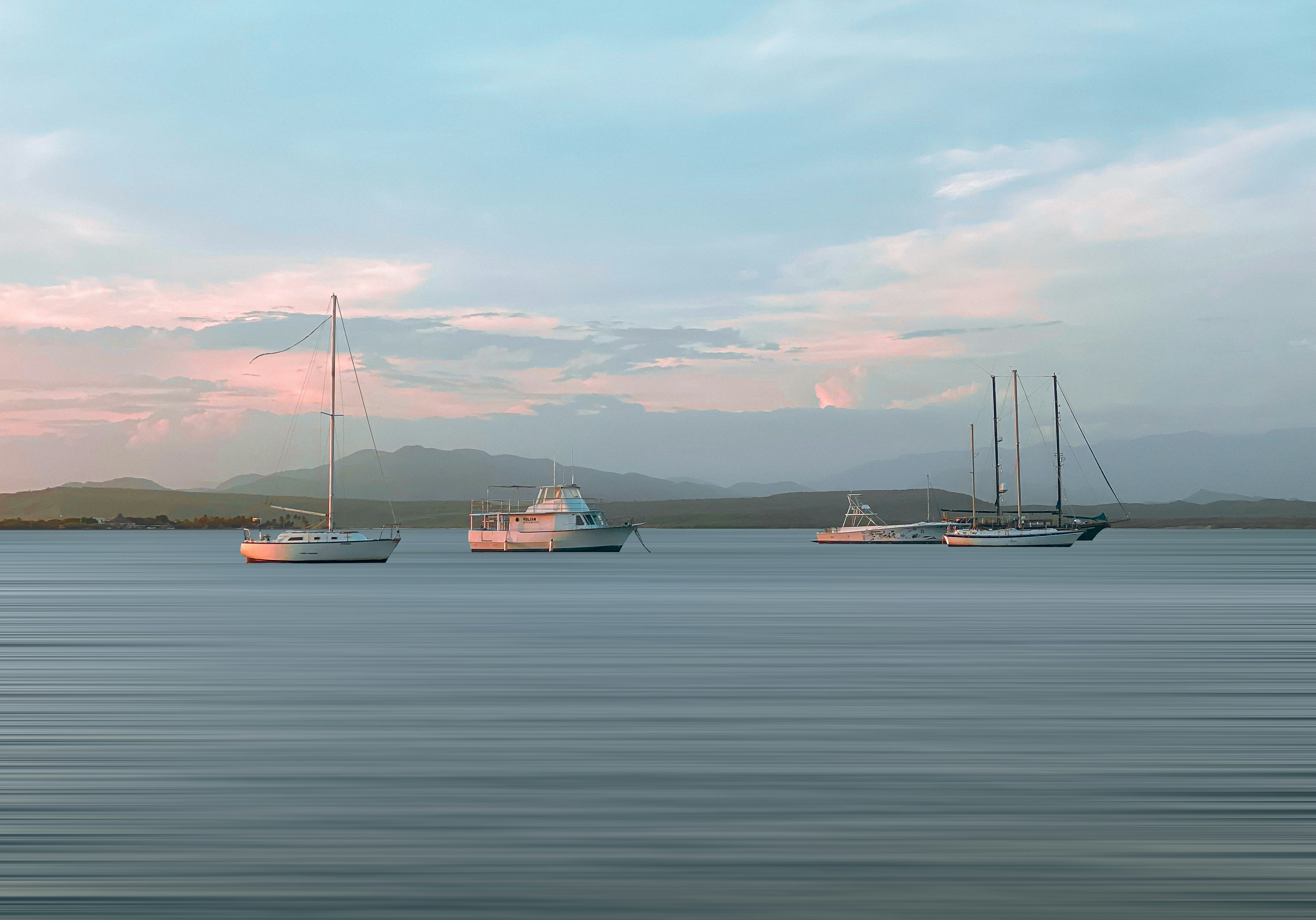 Pastel Parade: Boats Rest on a Glassy Dusk Sea