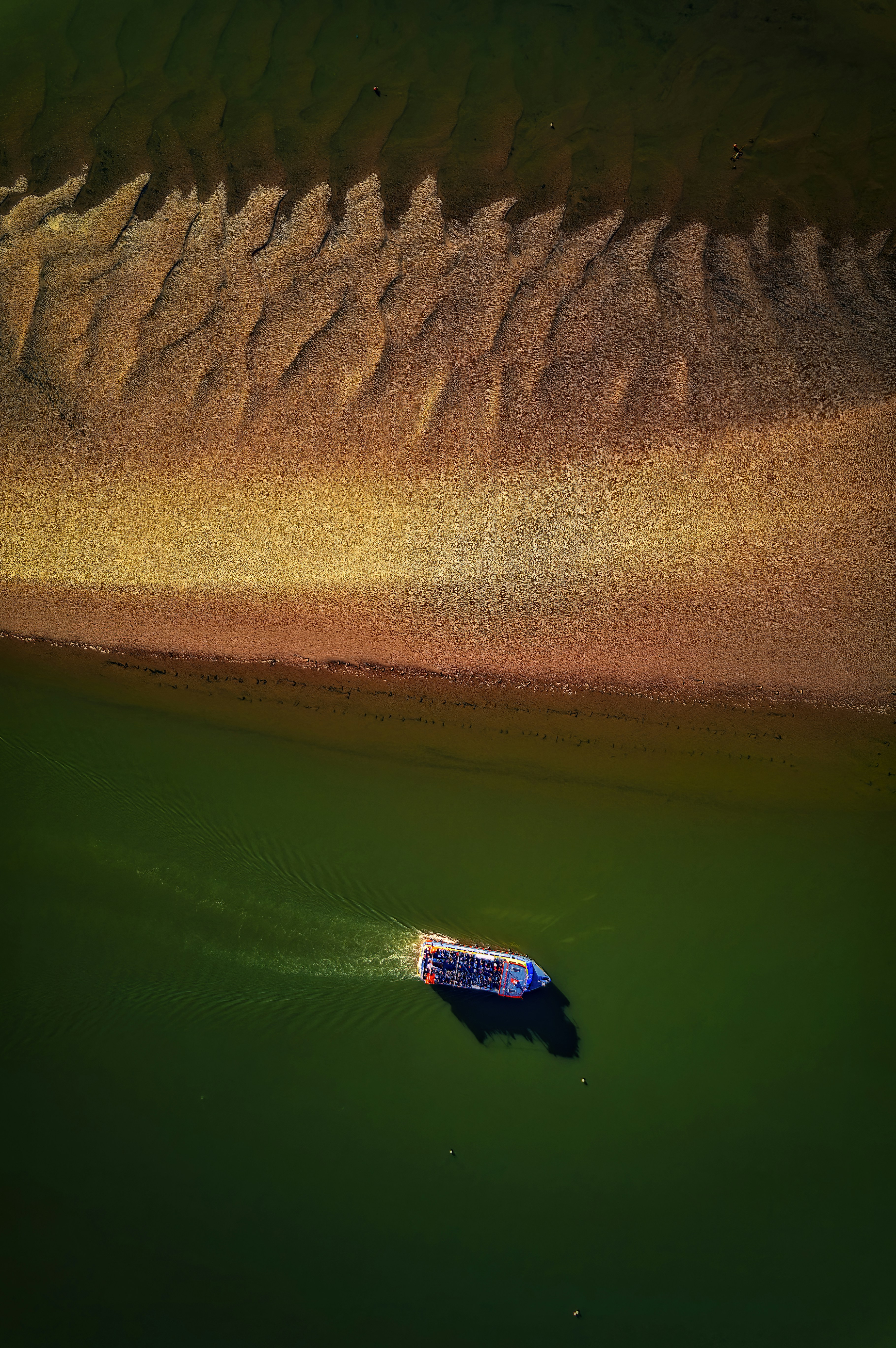Cargo Ship Carving Through Emerald Silence