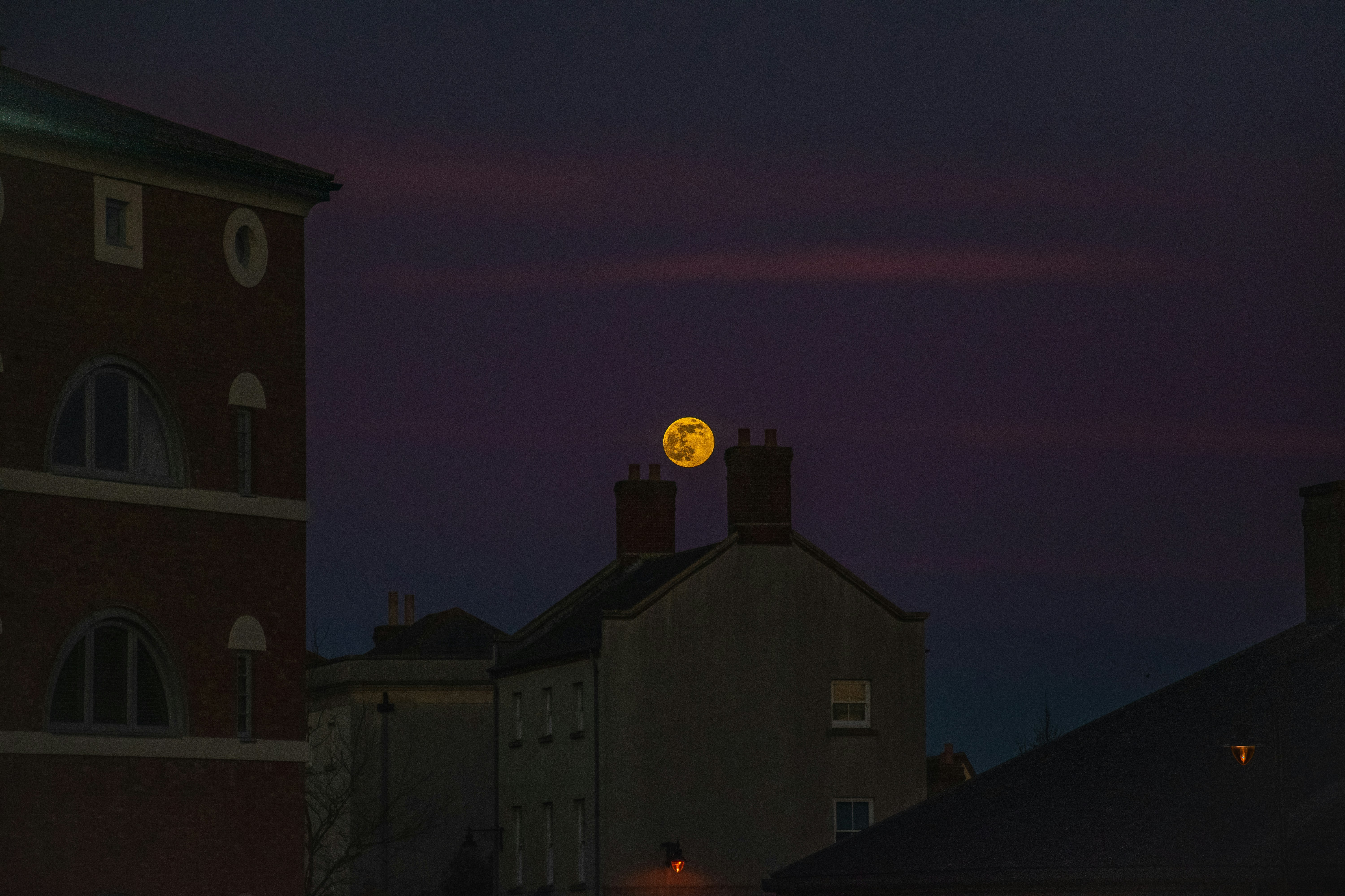 A full moon is seen over some buildings photo – Free Nature Image on ...