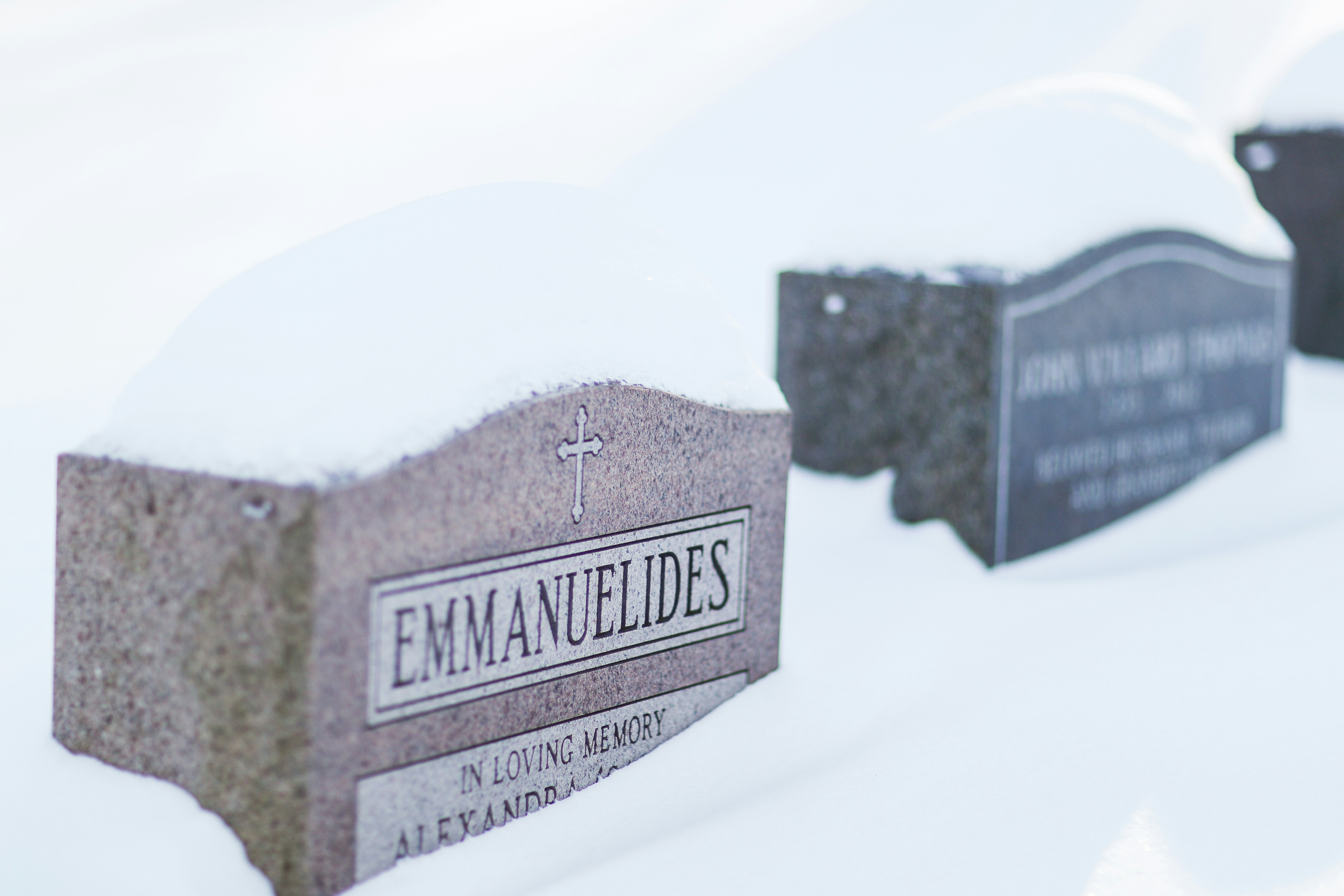 Snow-Lined Memorial: Emmanuelides Gravestone in Quiet Winter Light