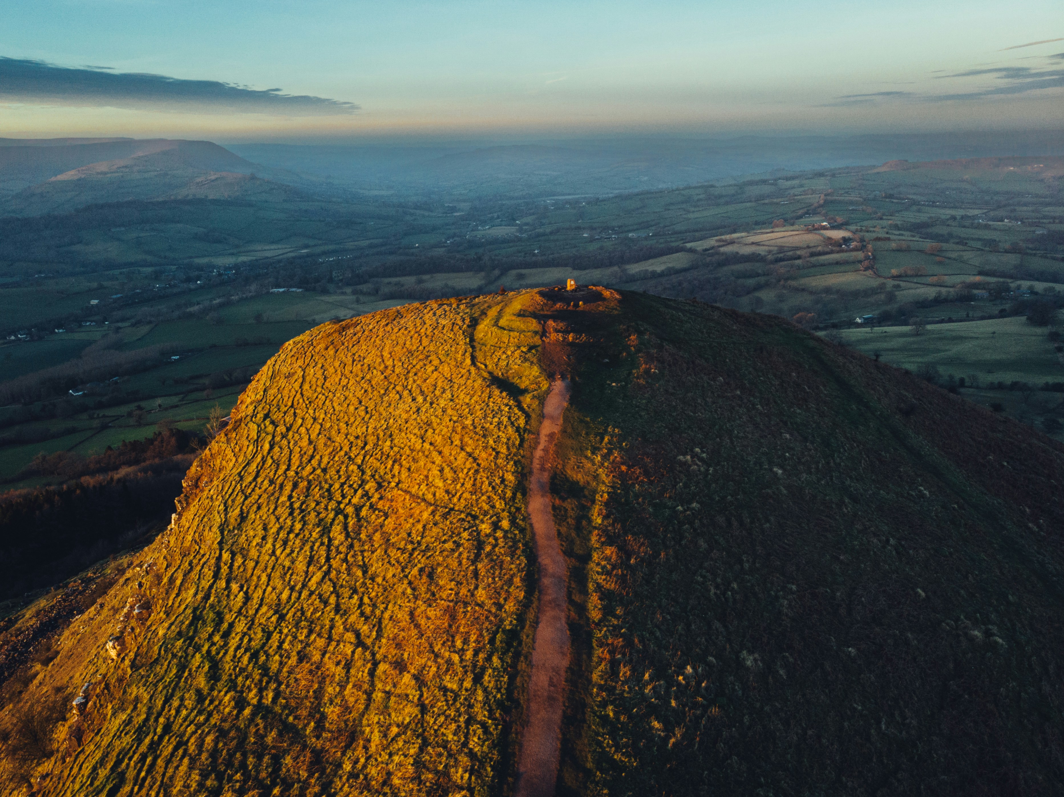 Golden Ridge: Aerial Crest Above the Valley at Sunset