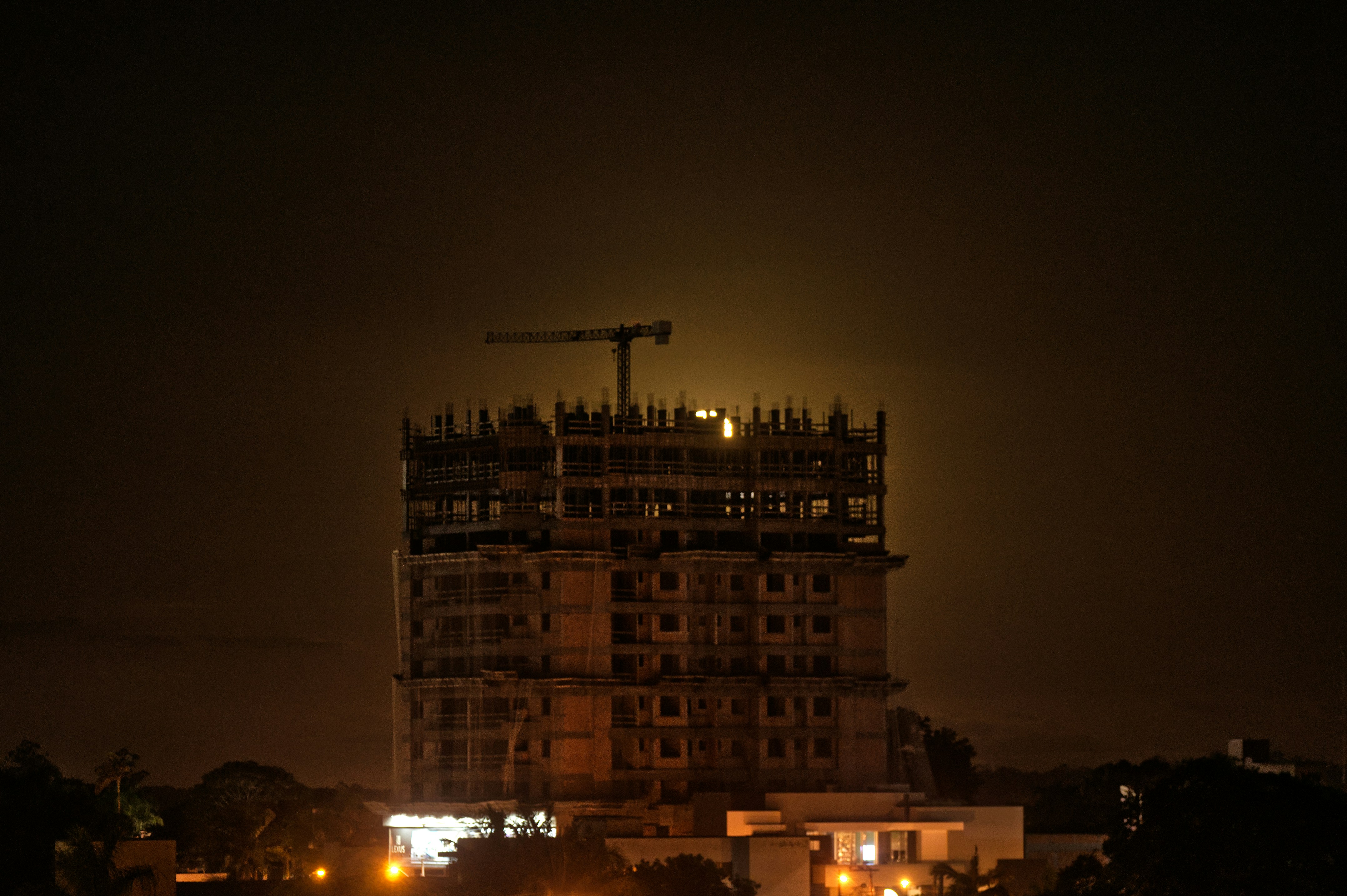 Crane Crown at Amber Night: A Tower Under Construction Emerges