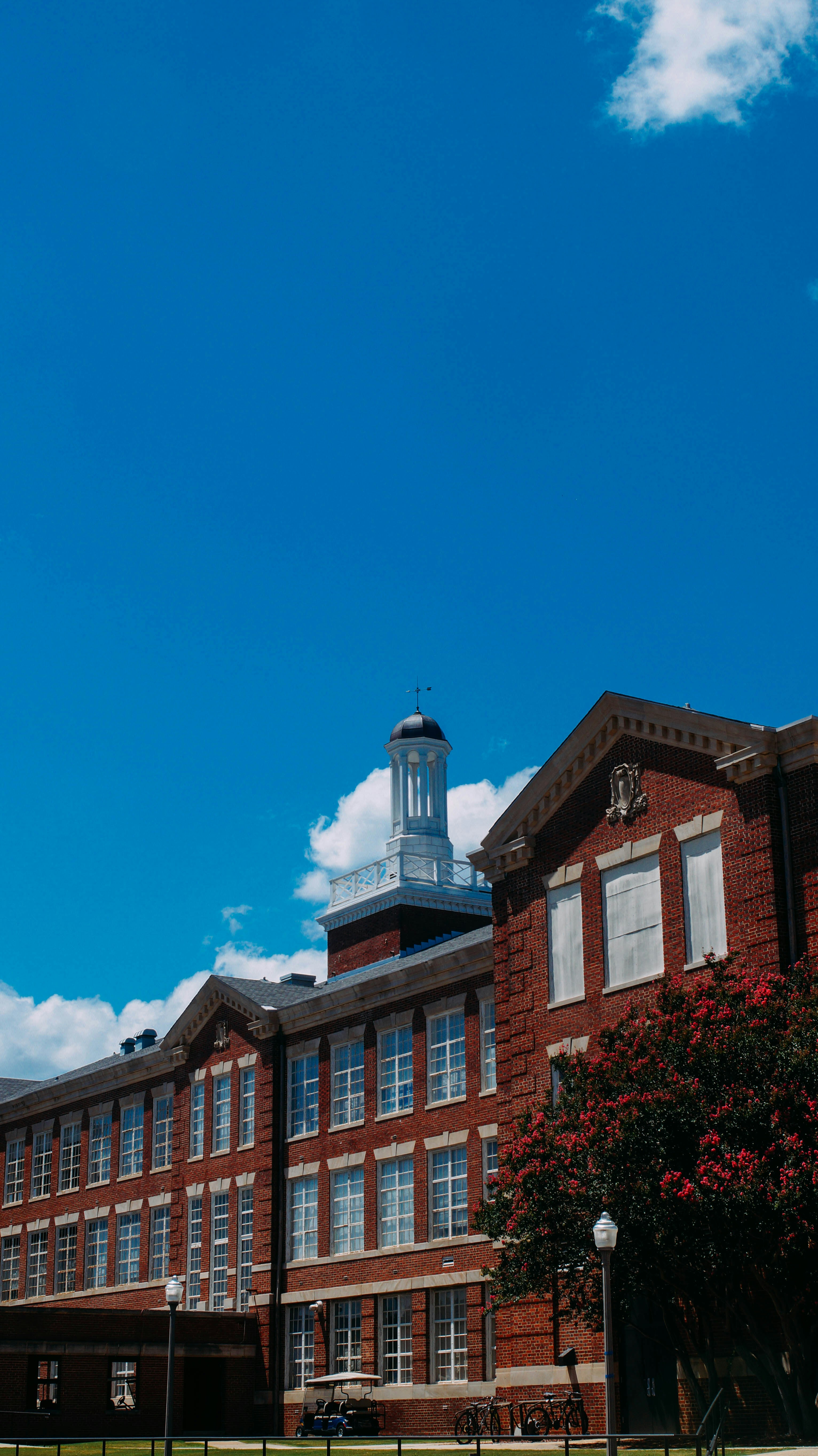 A large brick building with a clock tower on top photo – Free Auburn ...