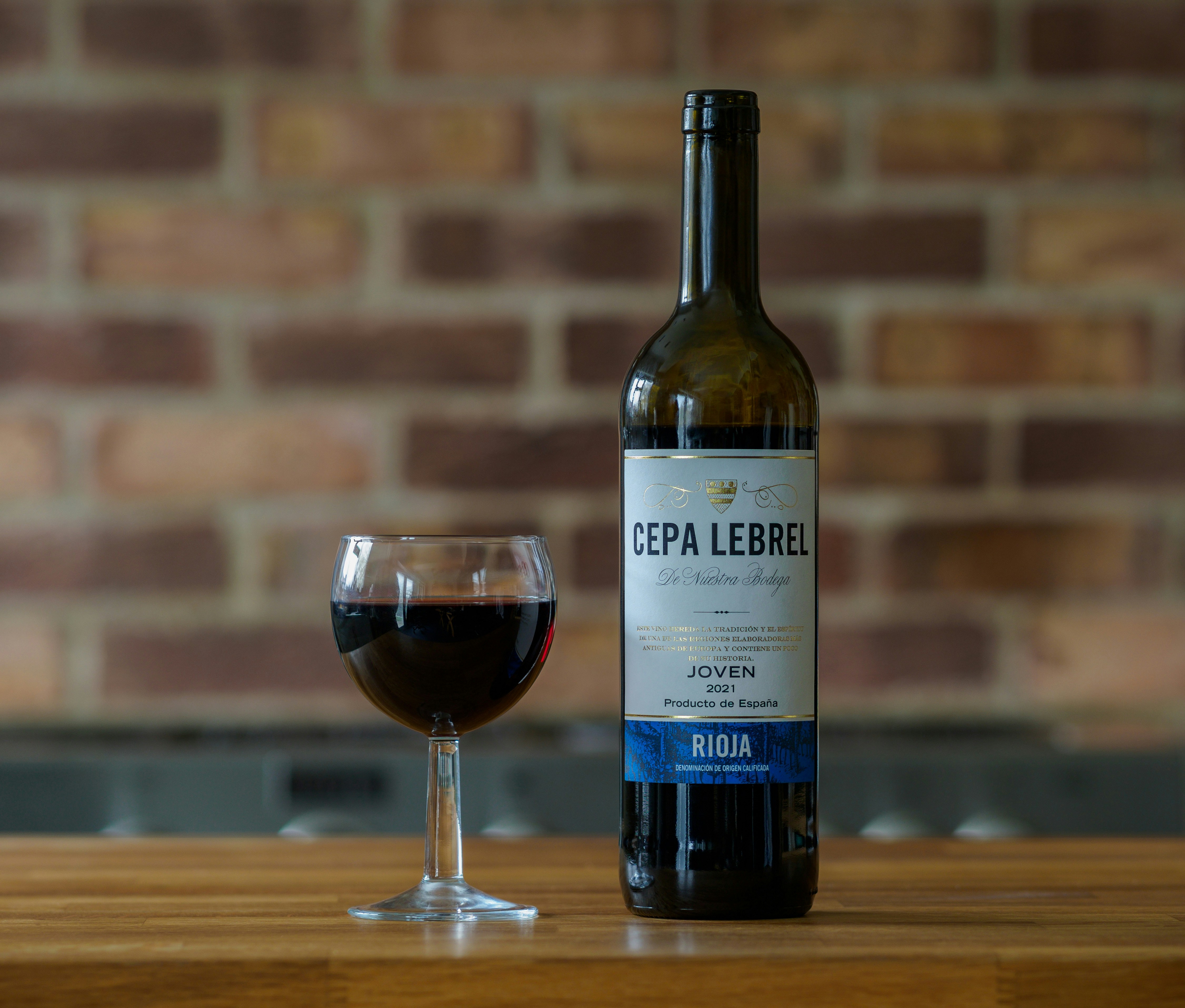 A bottle of wine and a glass on a table photo – Free Wine bottle Image ...