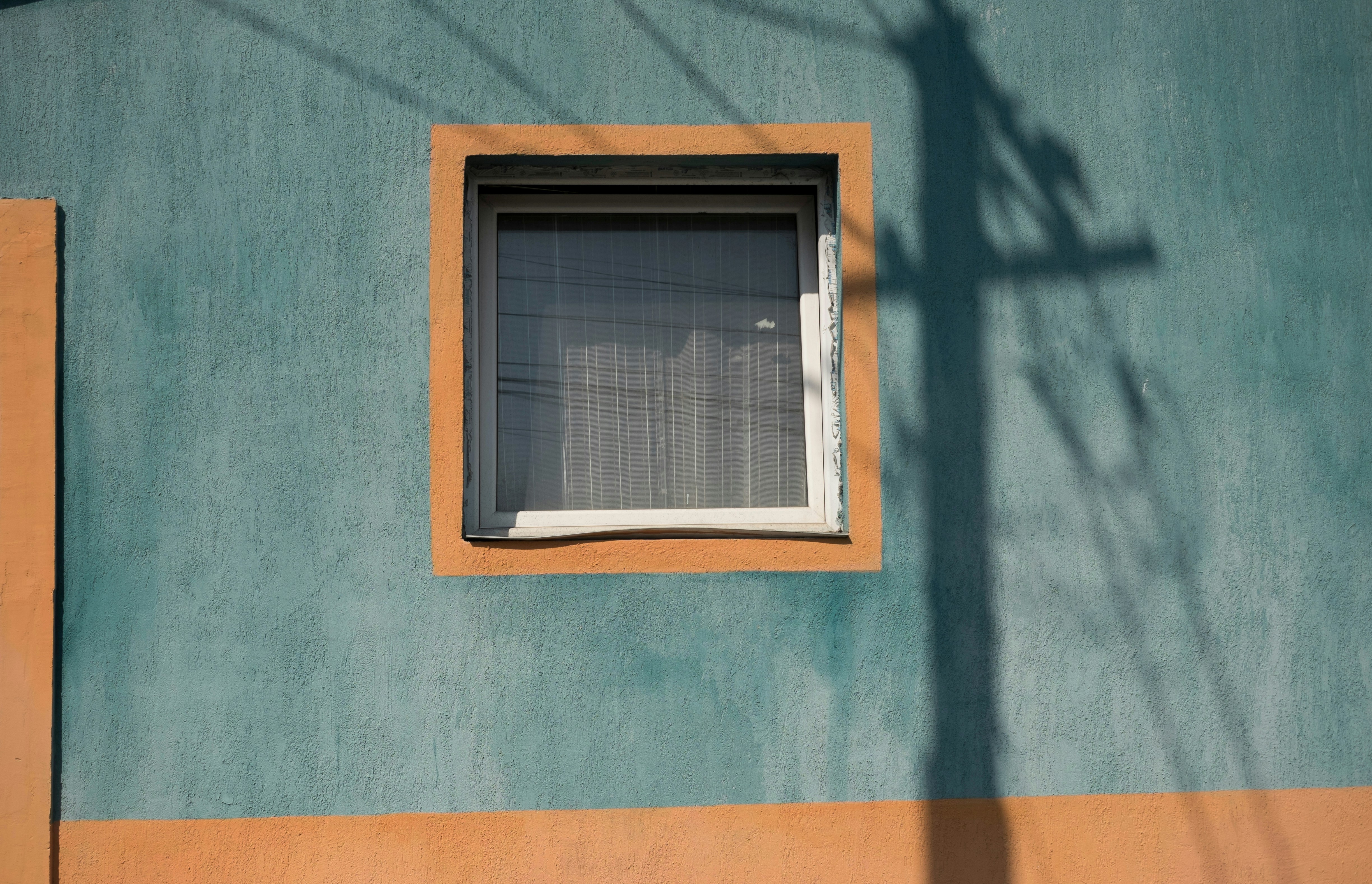 A window on the side of a building photo – Free Pastel background Image ...