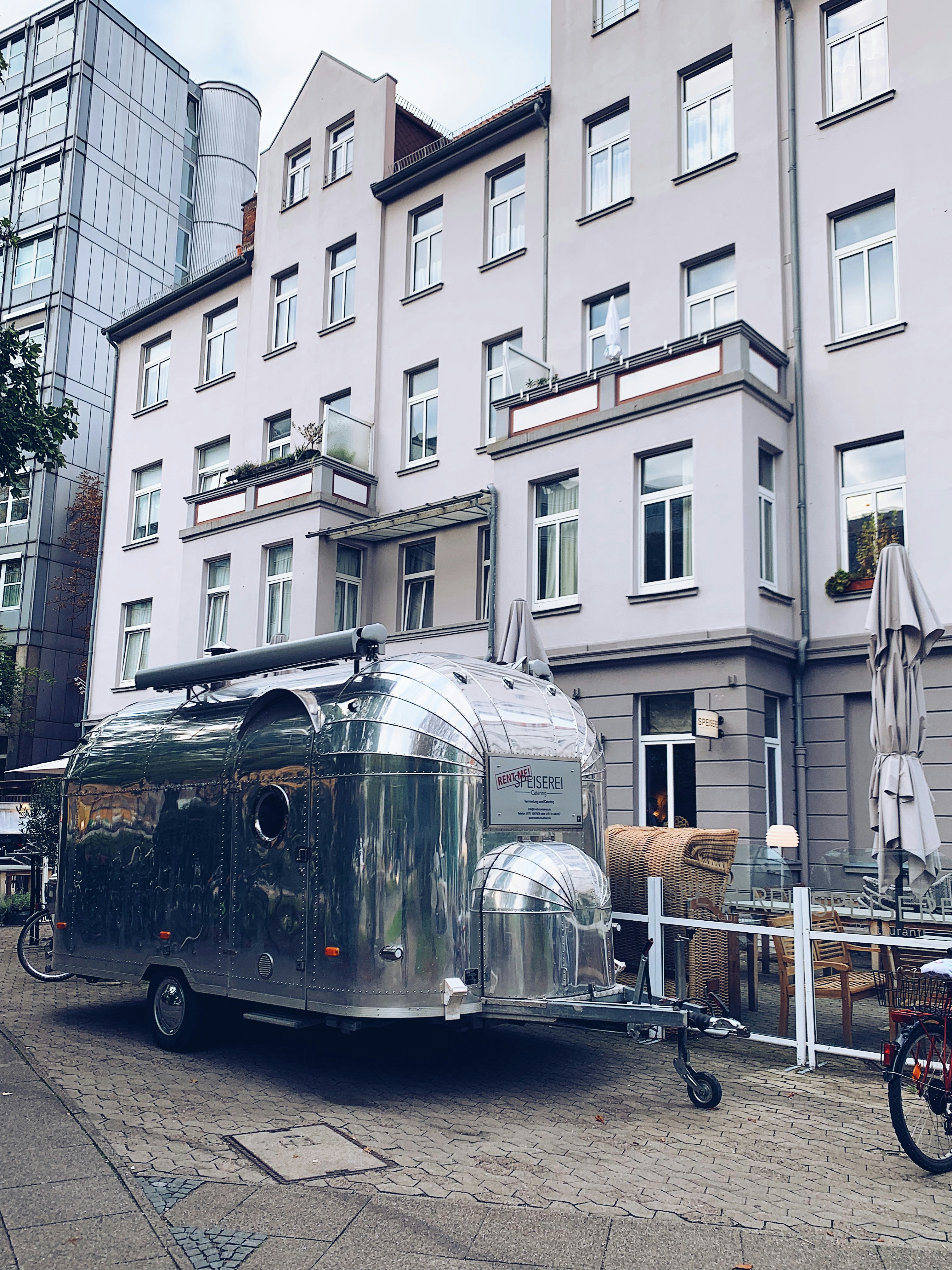 Polished Airstream Caravan Anchors the Urban Courtyard
