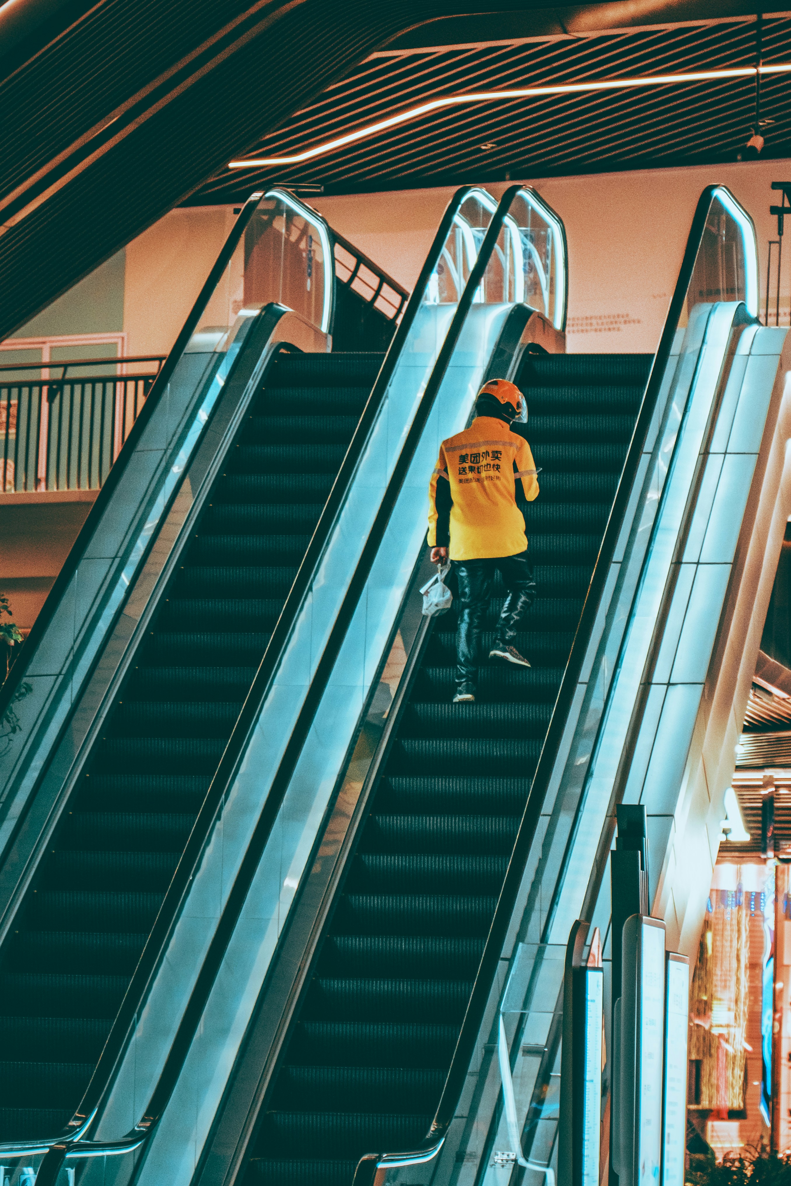 A man riding an escalator down a set of stairs photo – Free Shanghai ...