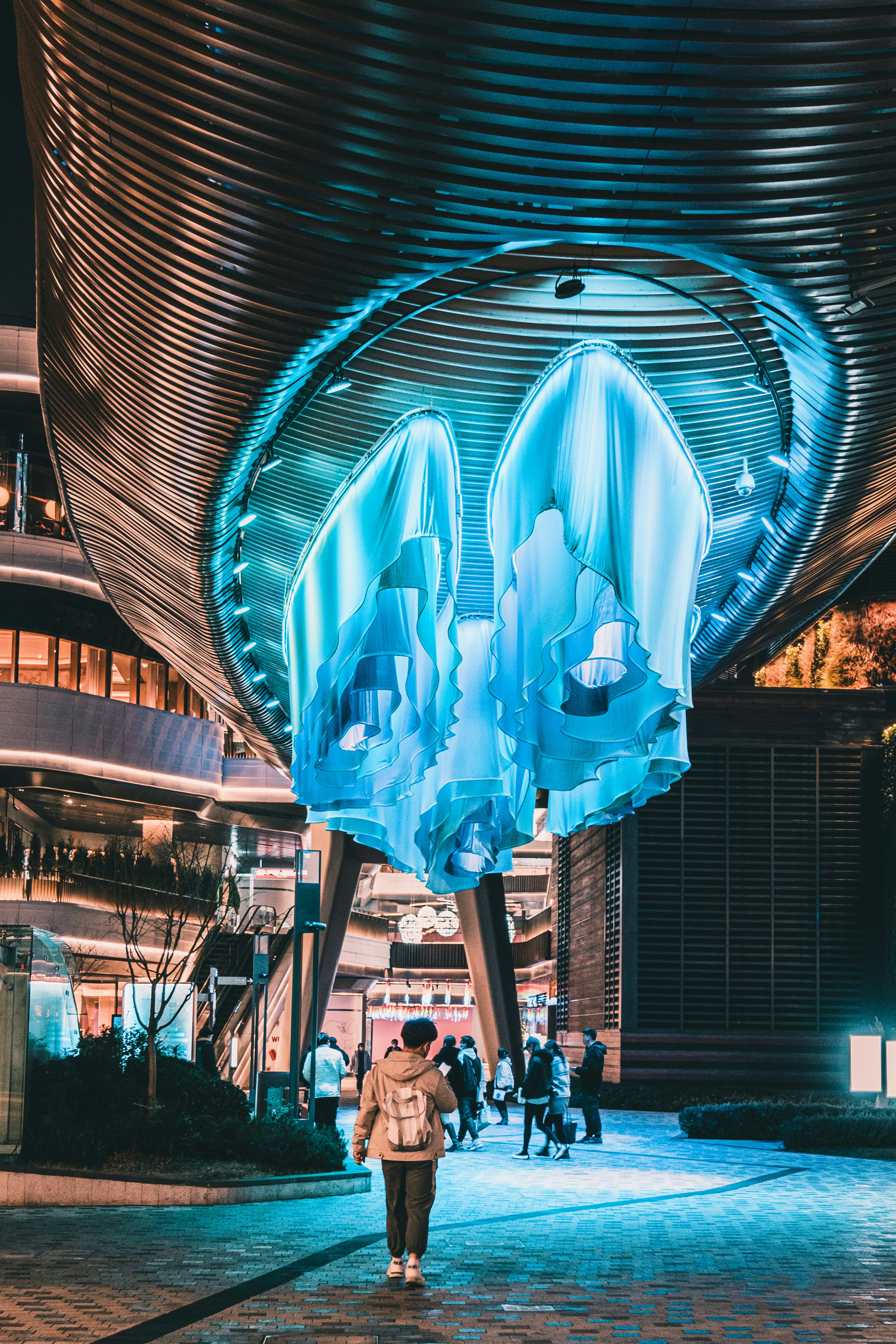 Blue Curtains under a Futuristic Canopy: Night Walk Beneath a Marble Sky