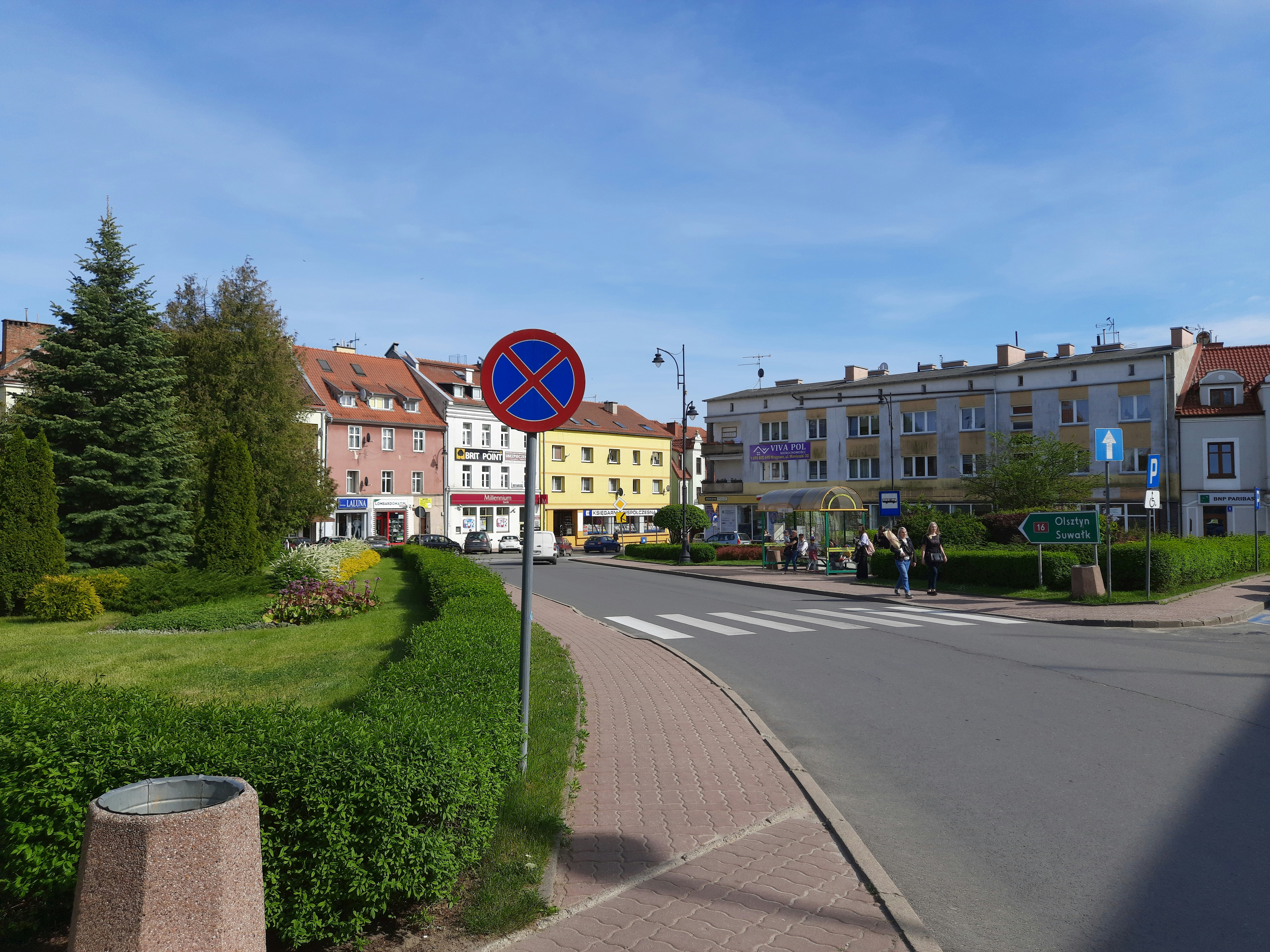 A blue and red street sign sitting on the side of a road photo – Free ...