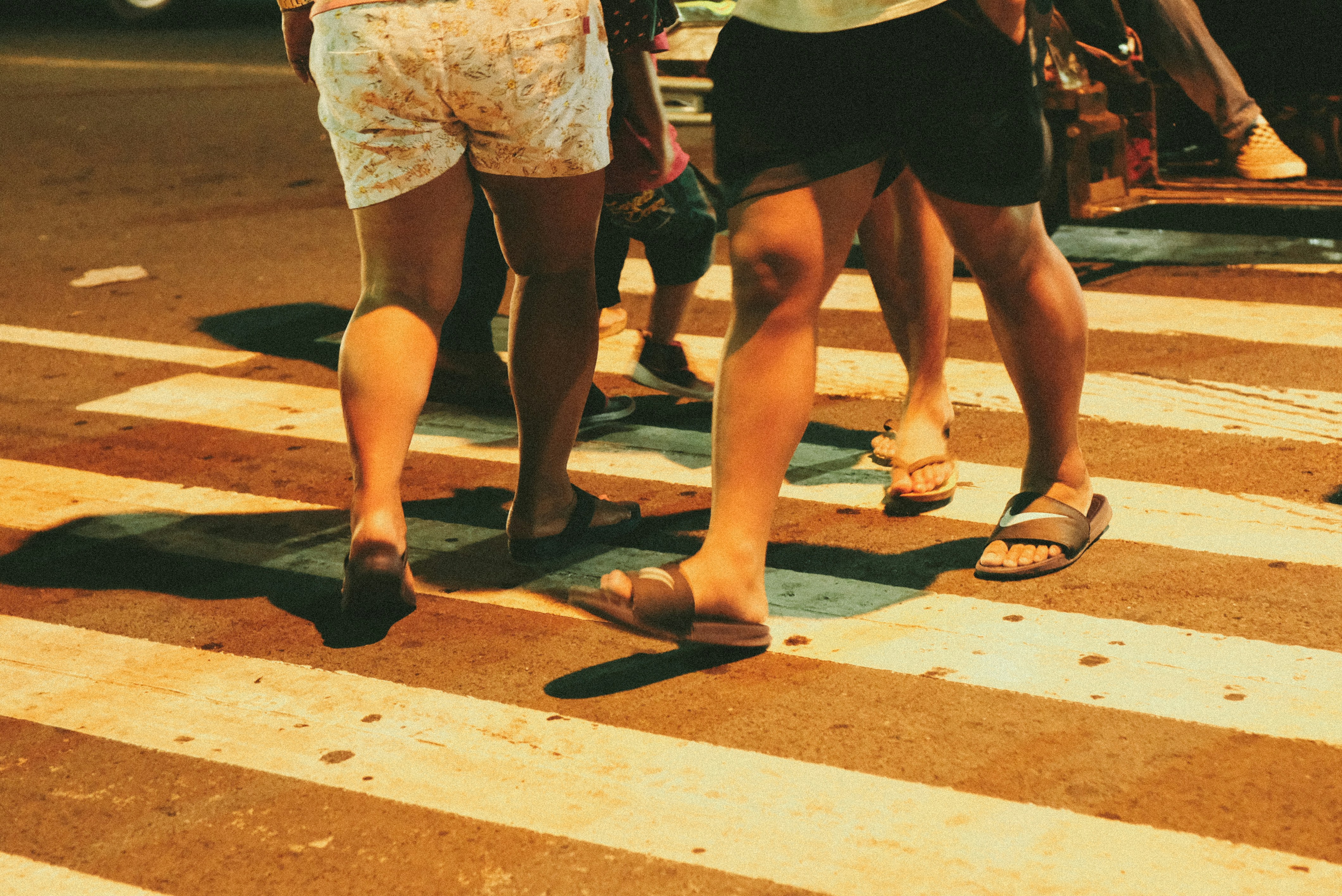 A group of people walking across a cross walk photo – Free Street ...