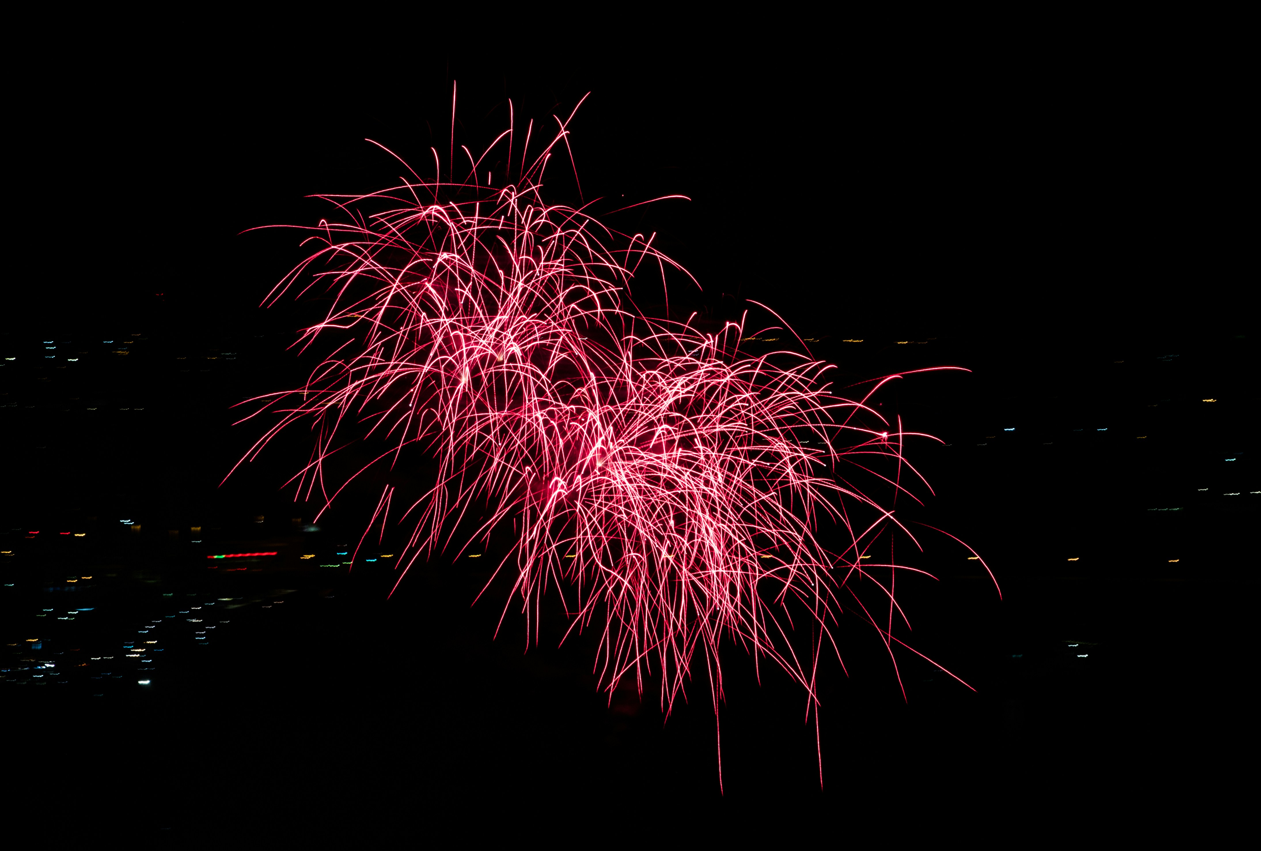 Crimson Fireflower Over a Quiet Urban Skyline