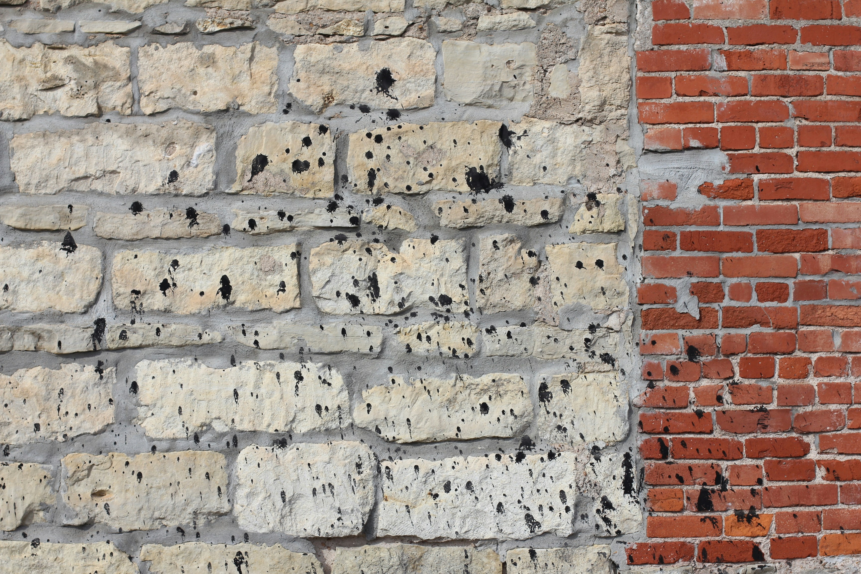 a close up of a brick wall with holes in it