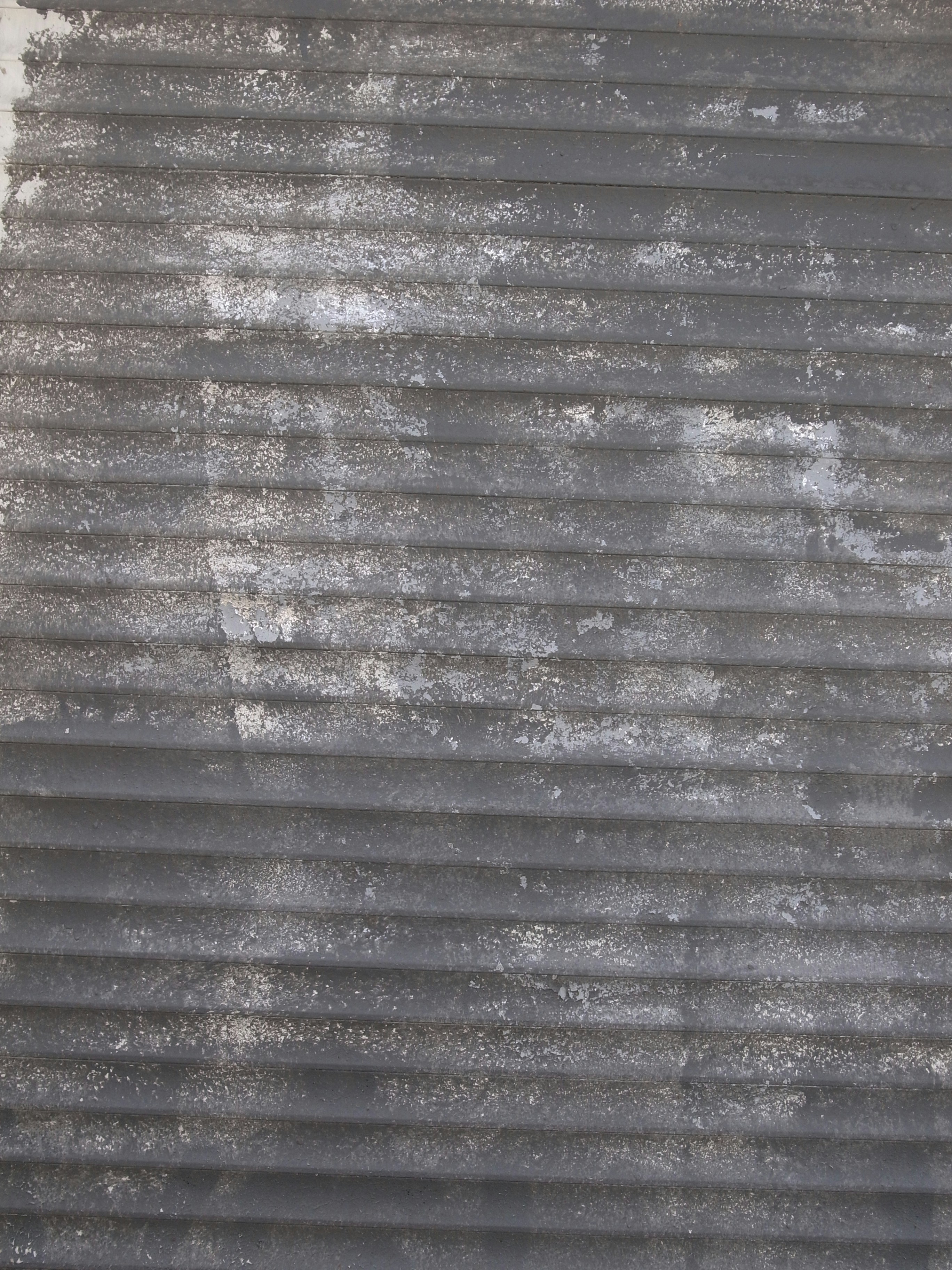 Weathered surface featuring horizontal lines and subtle textures, hinting at age and wear.