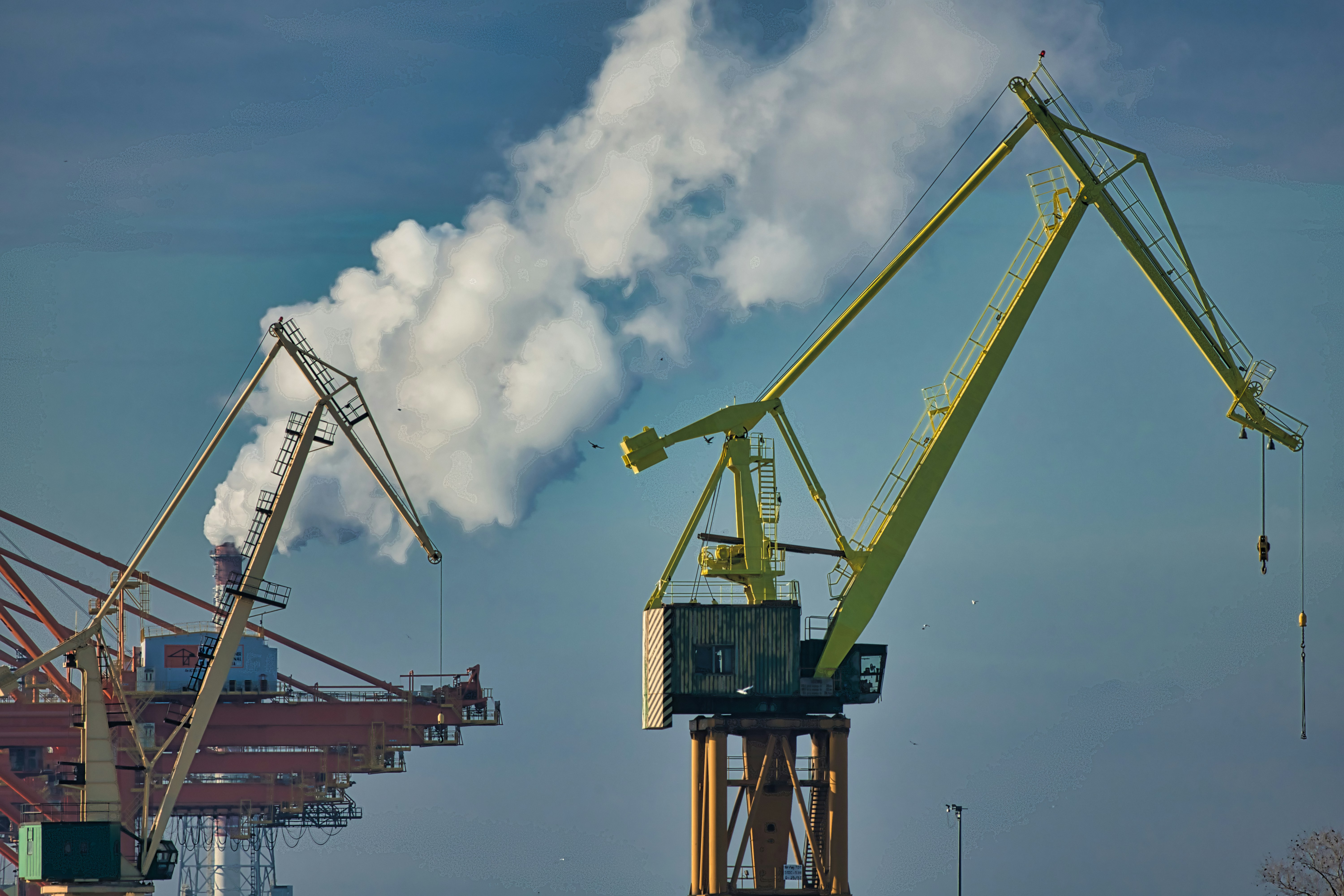 Emerald Arm Over Steam and Steel: A Port Crane Draws the Sky