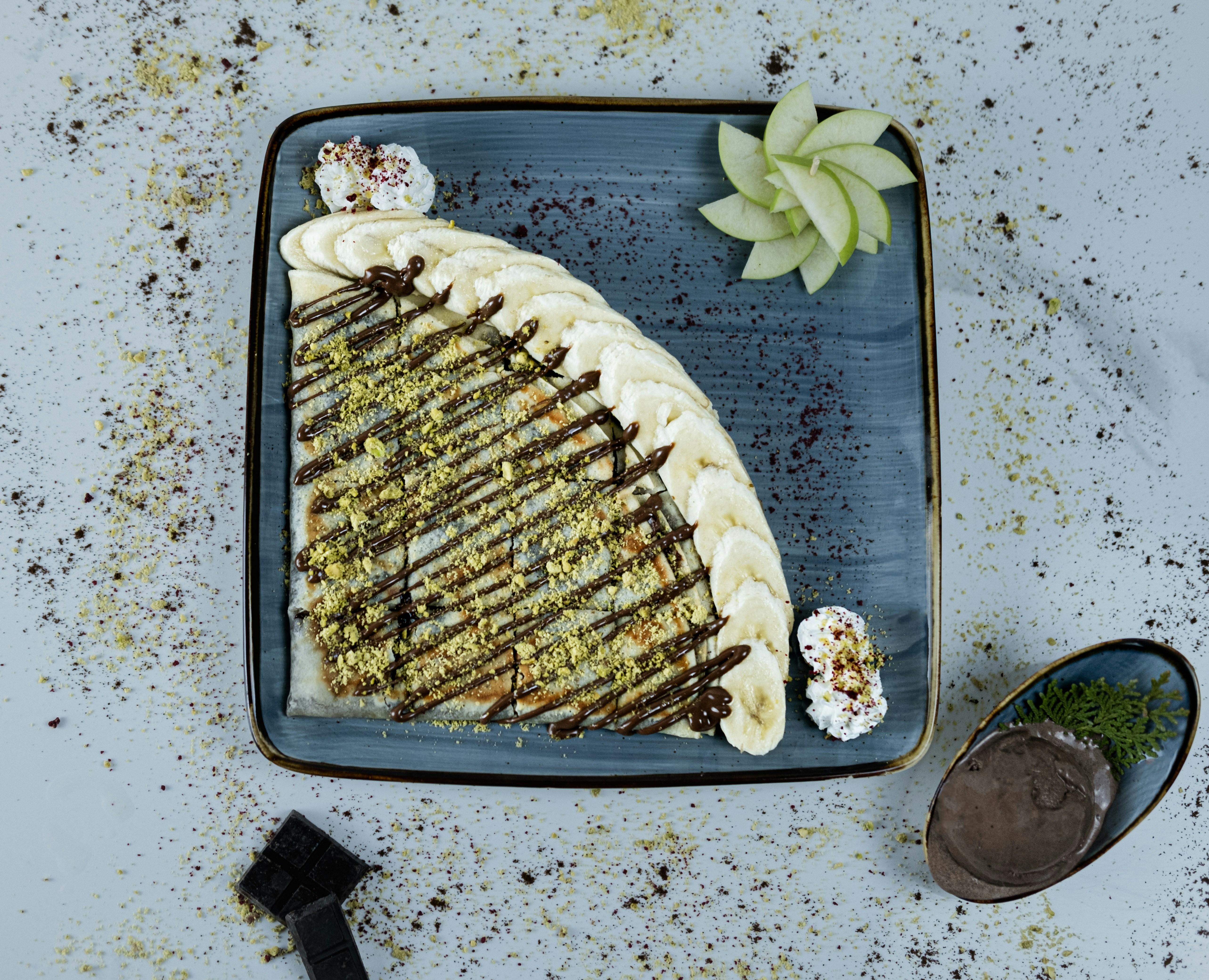 Slice of Banana Caramel Confit on a Slate Plate with Green Apple Succulent