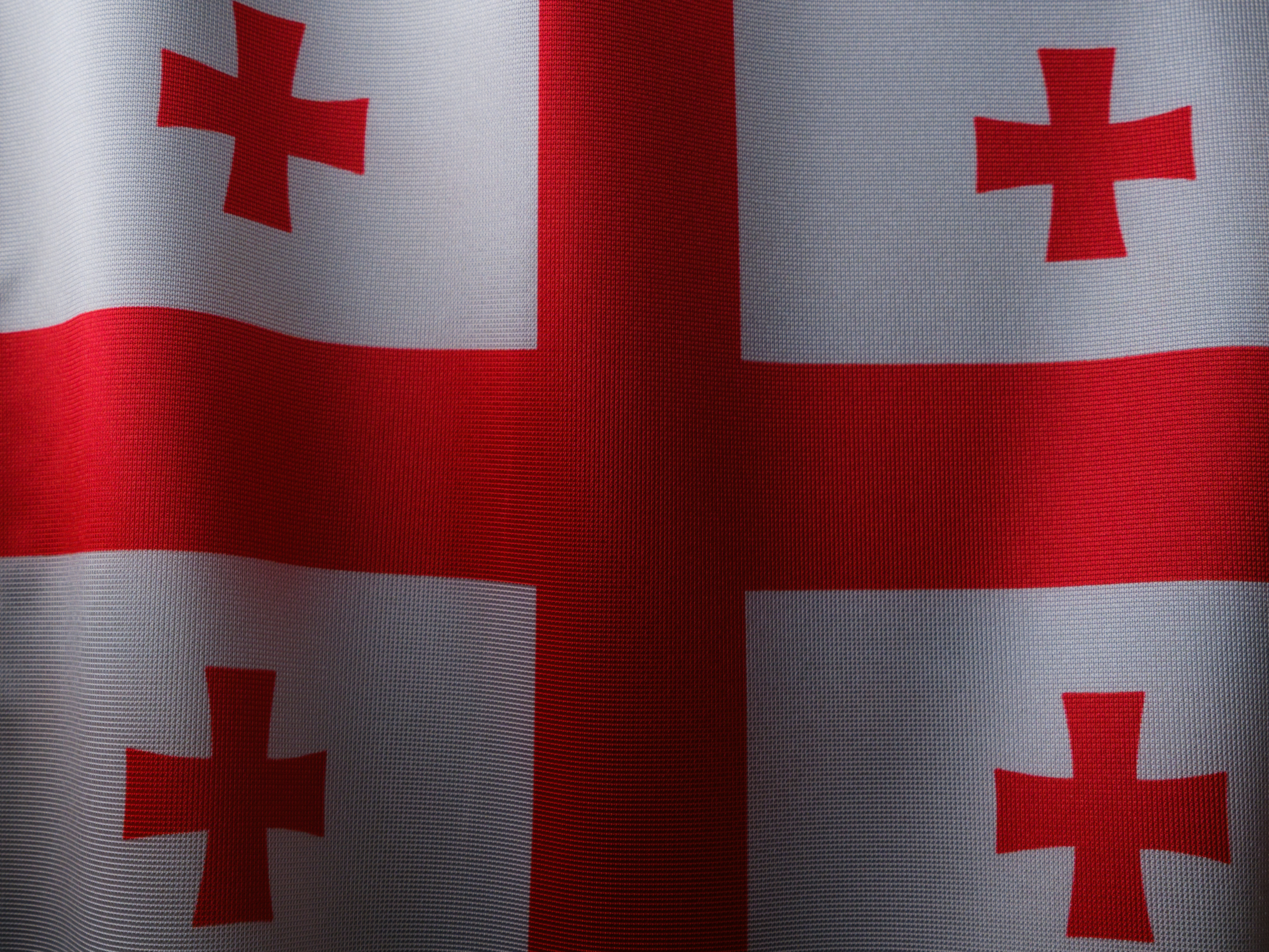A red and white flag with a cross on it photo – Free Flag Image on Unsplash