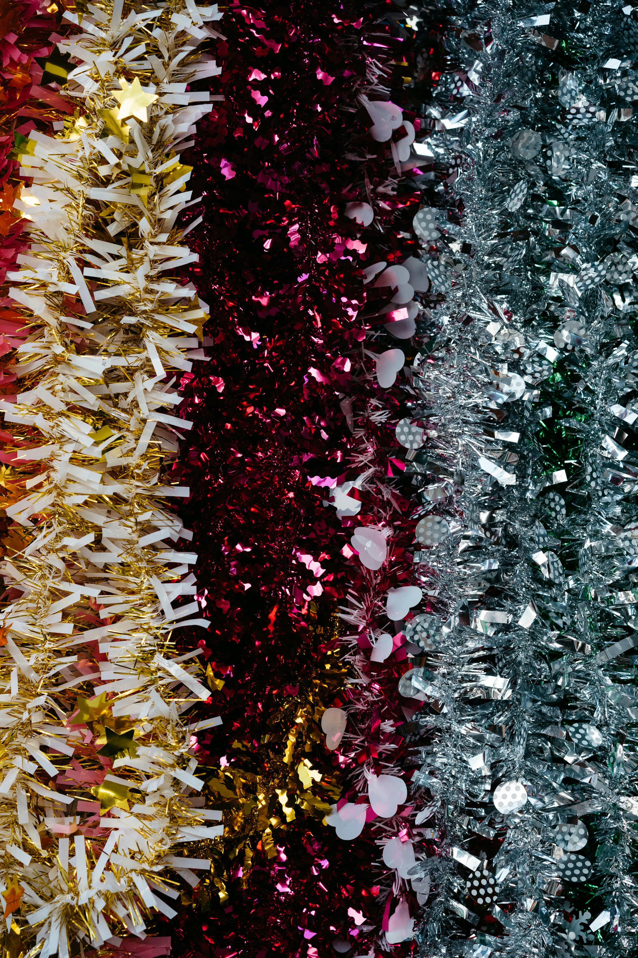 A bunch of different colored tinsel next to each other photo – Free ...