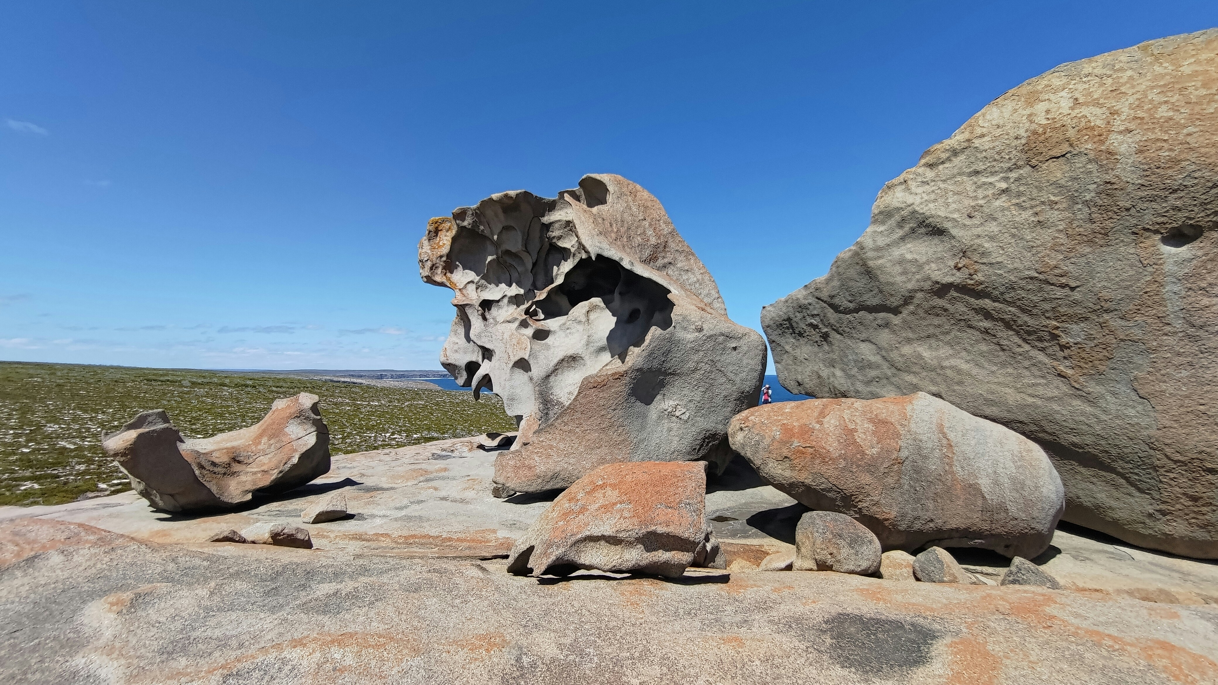 Weathered Sentinel: a cluster of sculpted rocks under a clear coastal sky