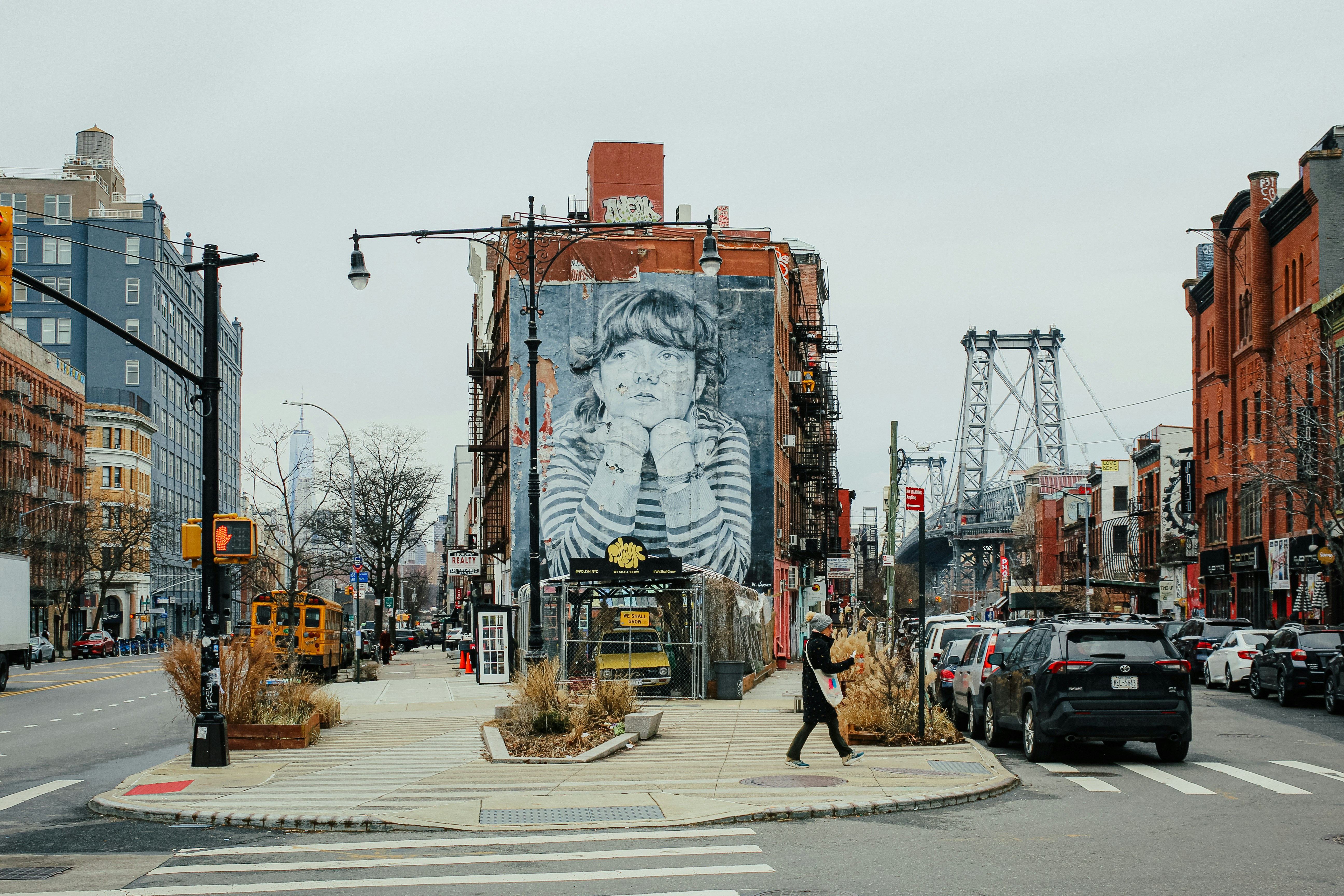 Brick-face Guardian: A Giant Mural Overlooks a Busy City Street