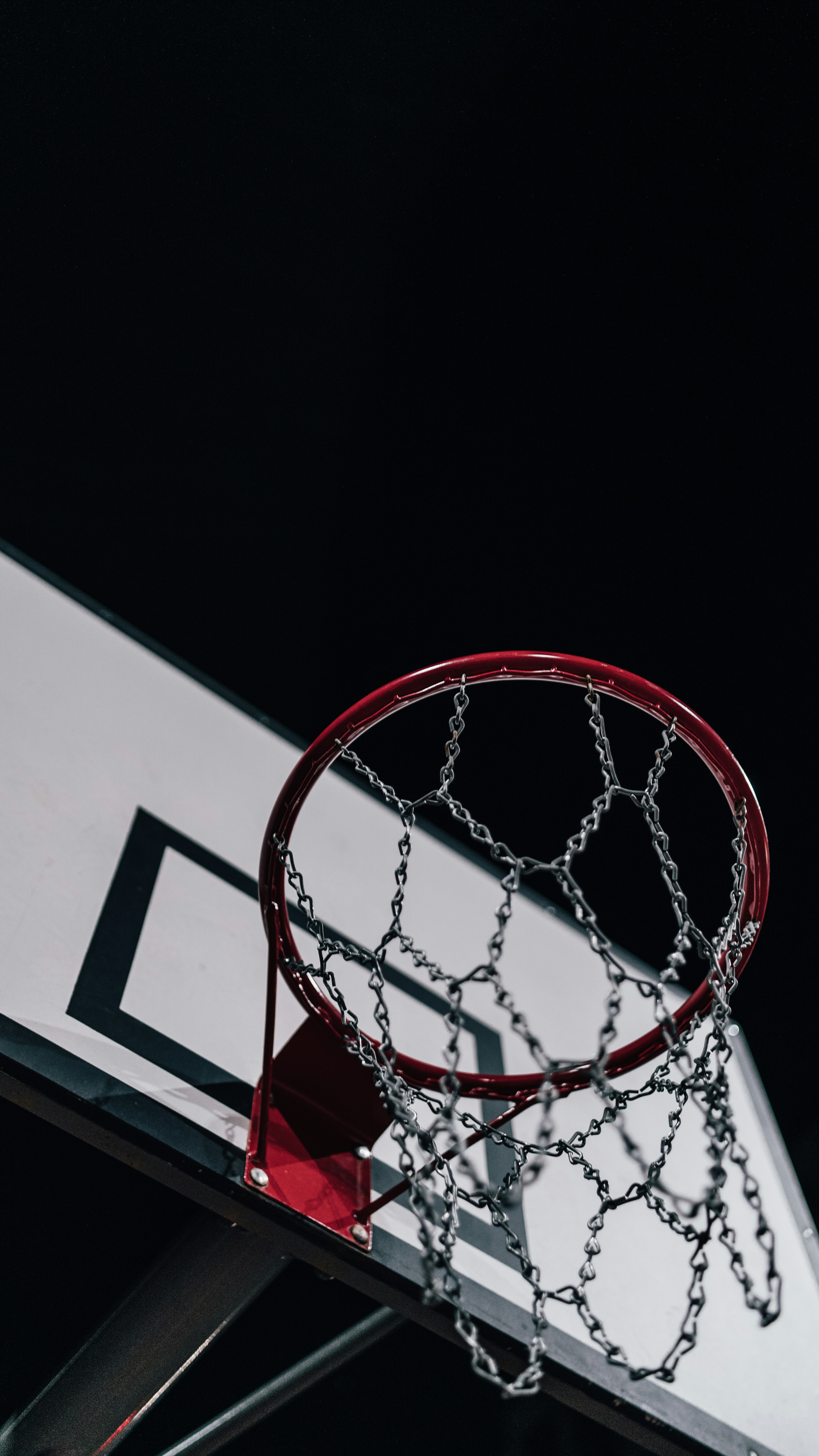 A close up of a basketball hoop with chains on it photo – Free ...