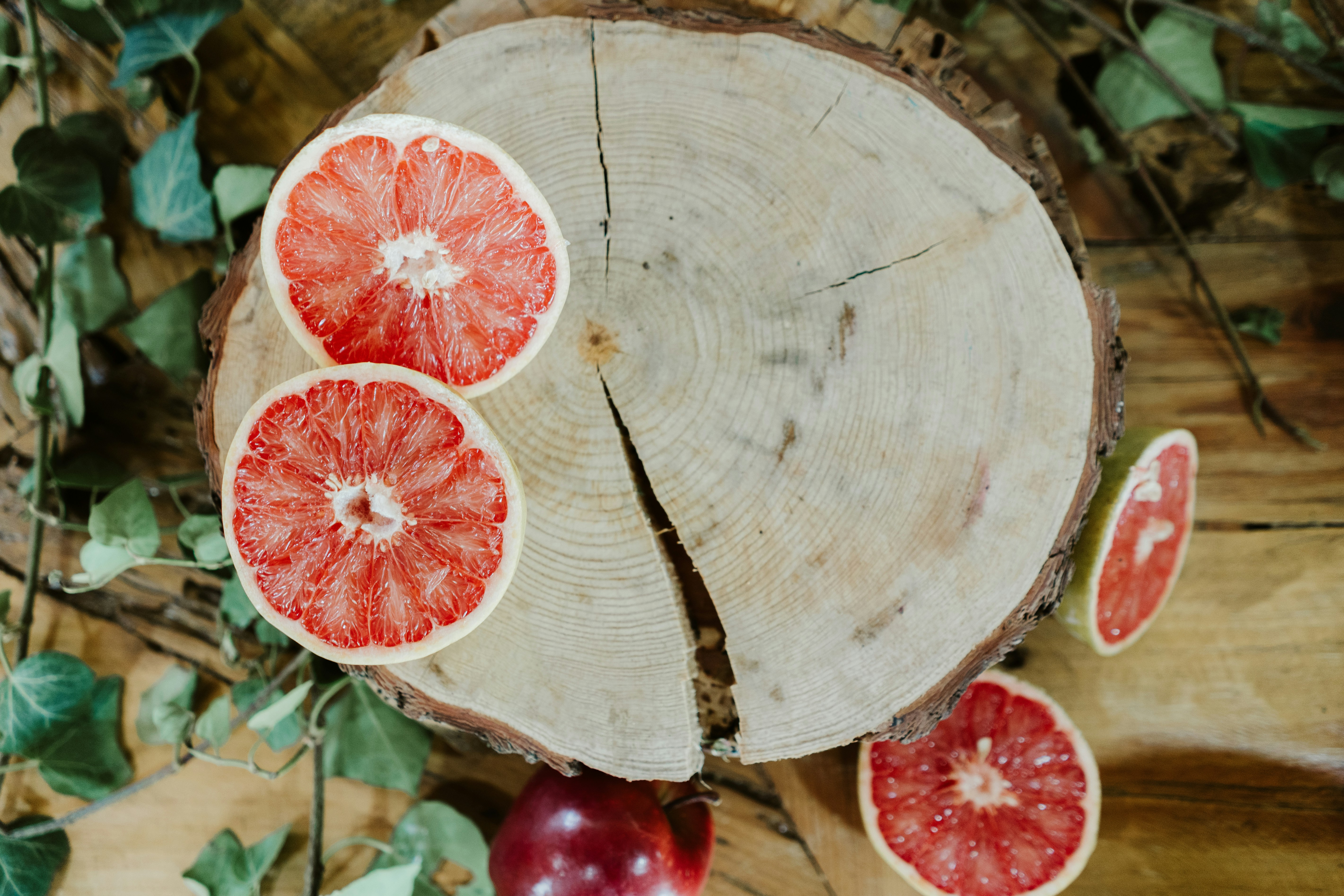 Grapefruit Halves Resting on a Weathered Tree Slice