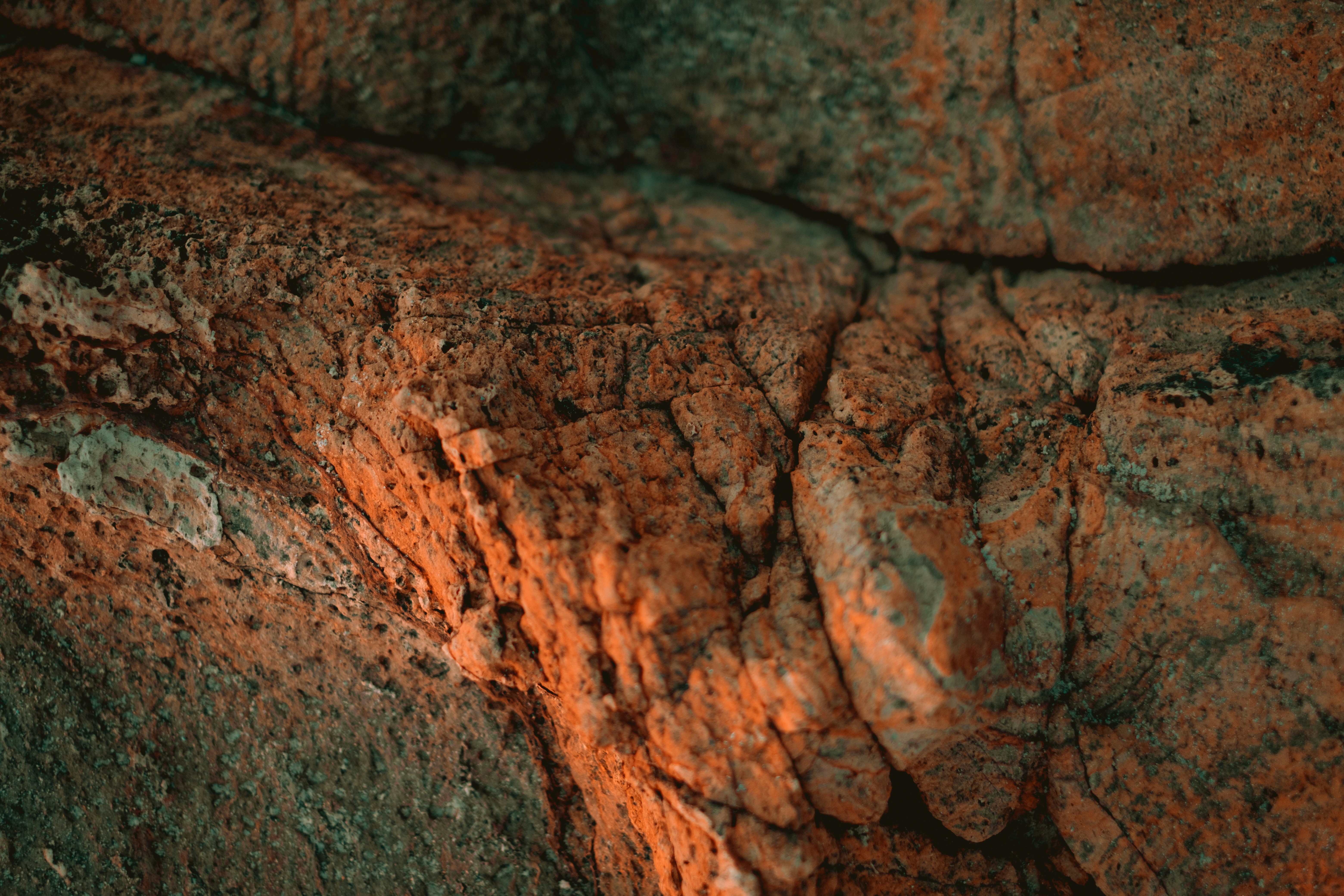 A close up of a rock face with a red glow photo – Free Rock Image on ...