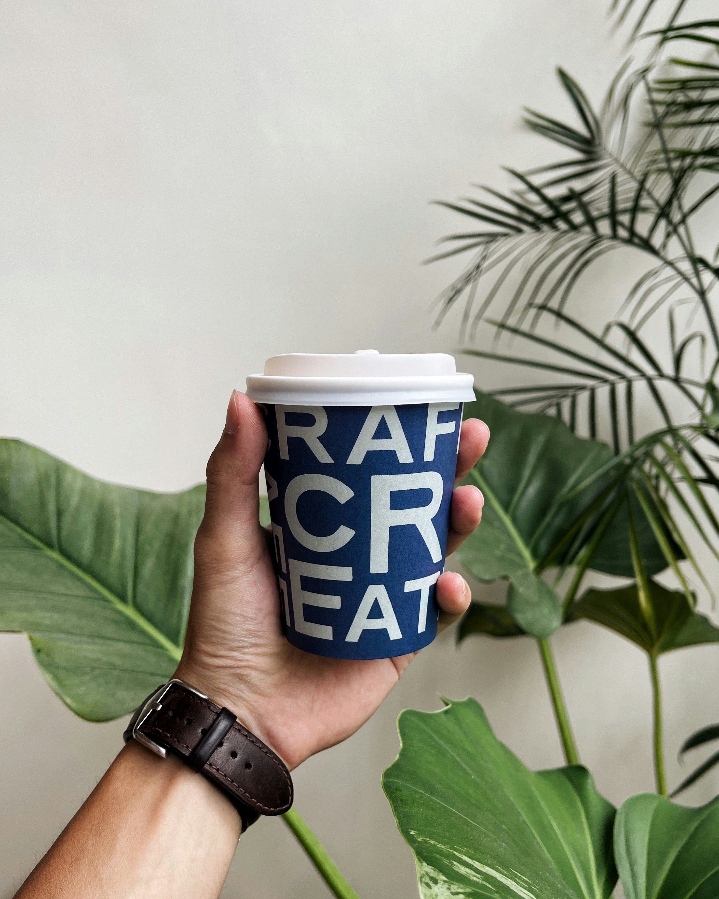 A hand holding a coffee cup with the words rah creat on it photo – Free ...