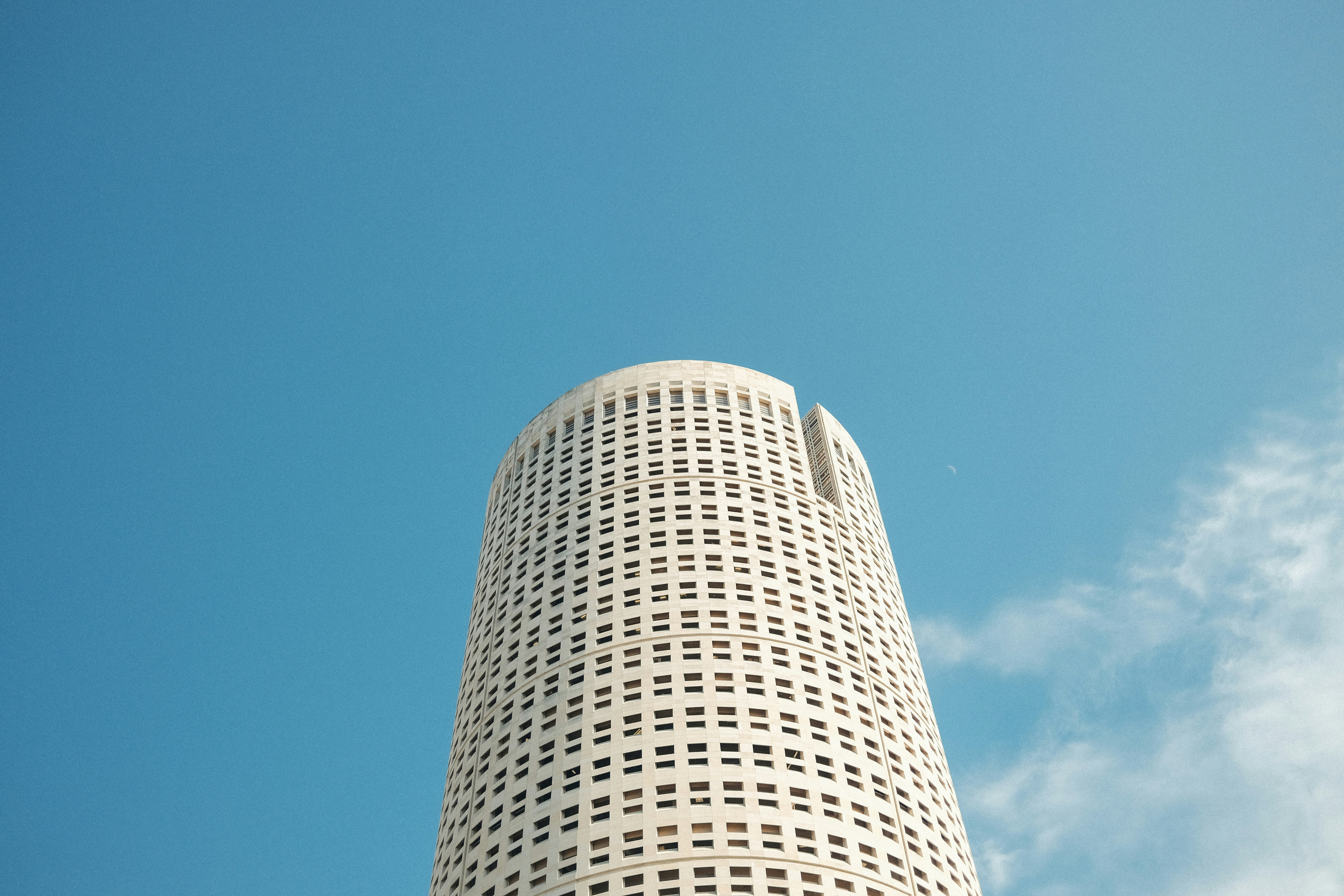 A tall white building with a sky background photo – Free Unique Image ...