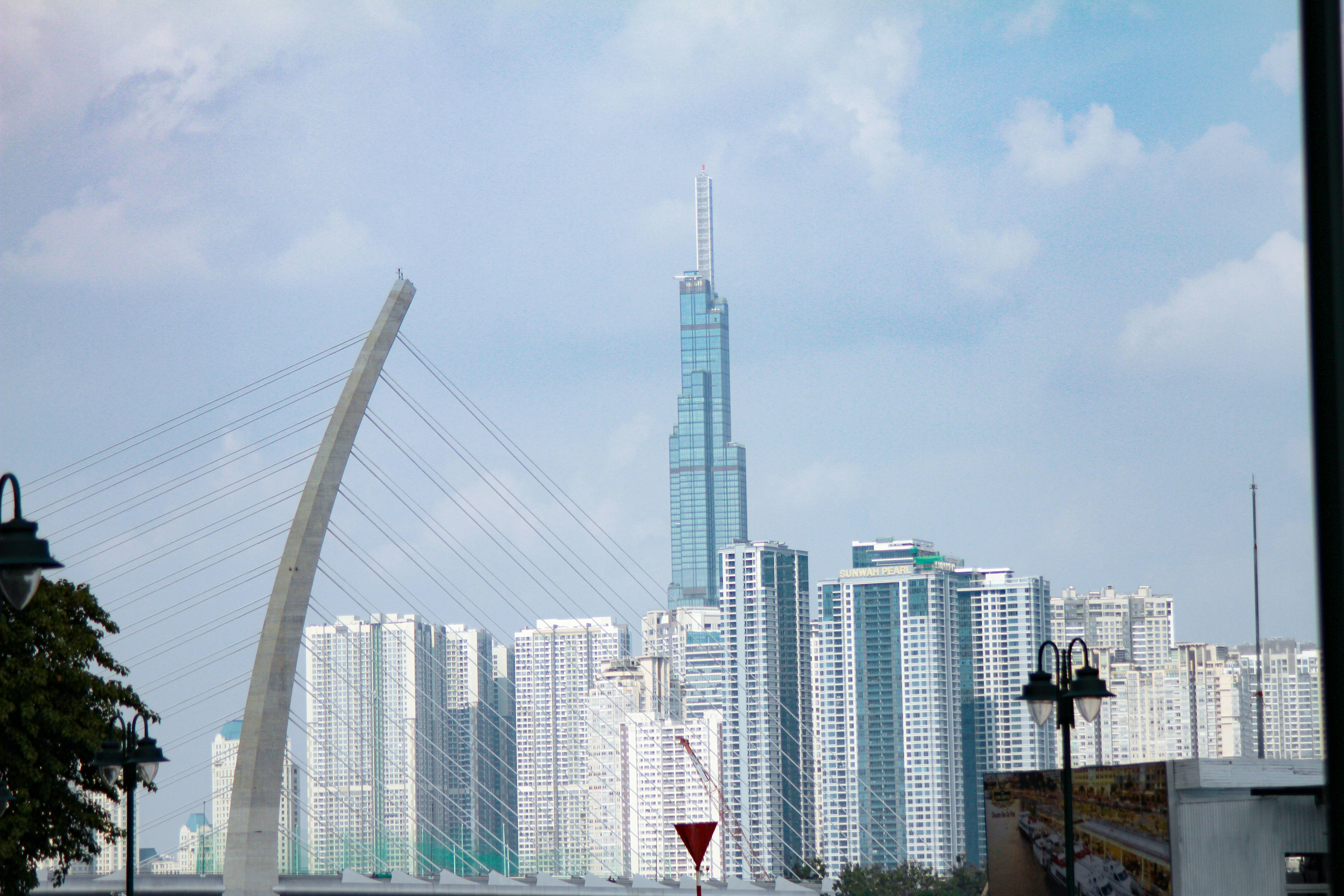 a view of a city with a bridge in the foreground