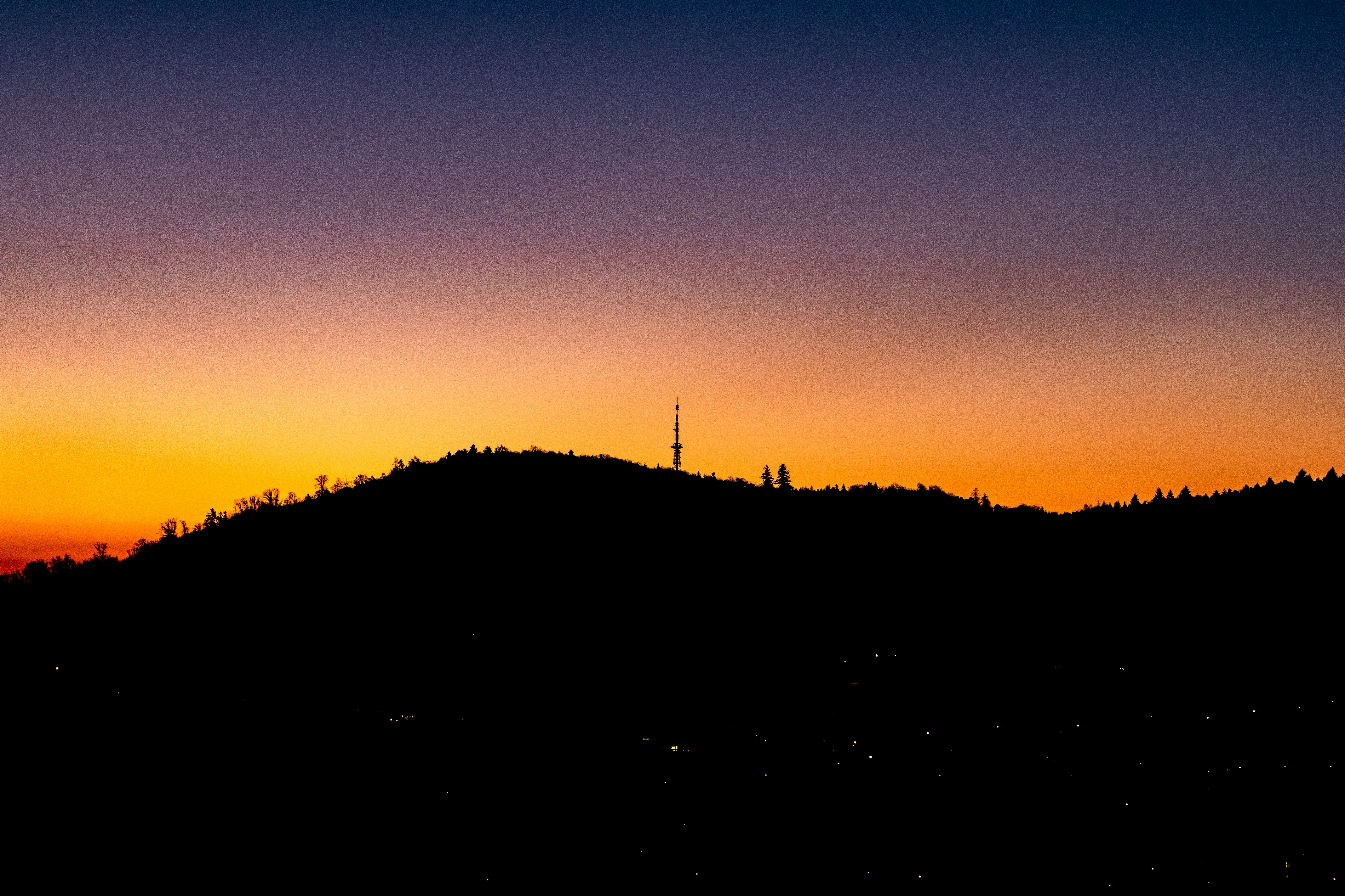 The sun is setting over a hill with trees on it photo – Free Sunset ...