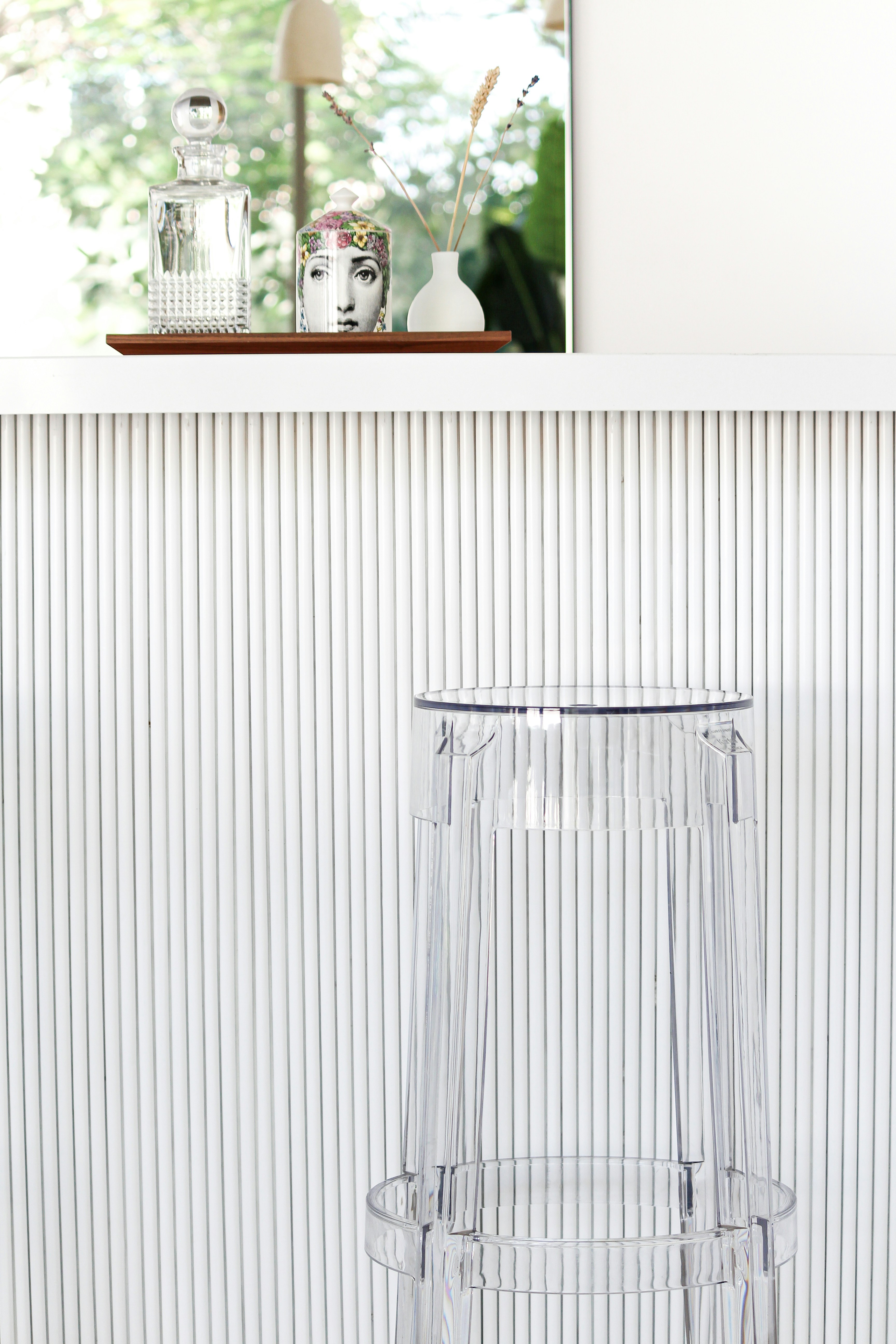 Portrait on a Shelf: Glass, Face, and Light on White Ribbing