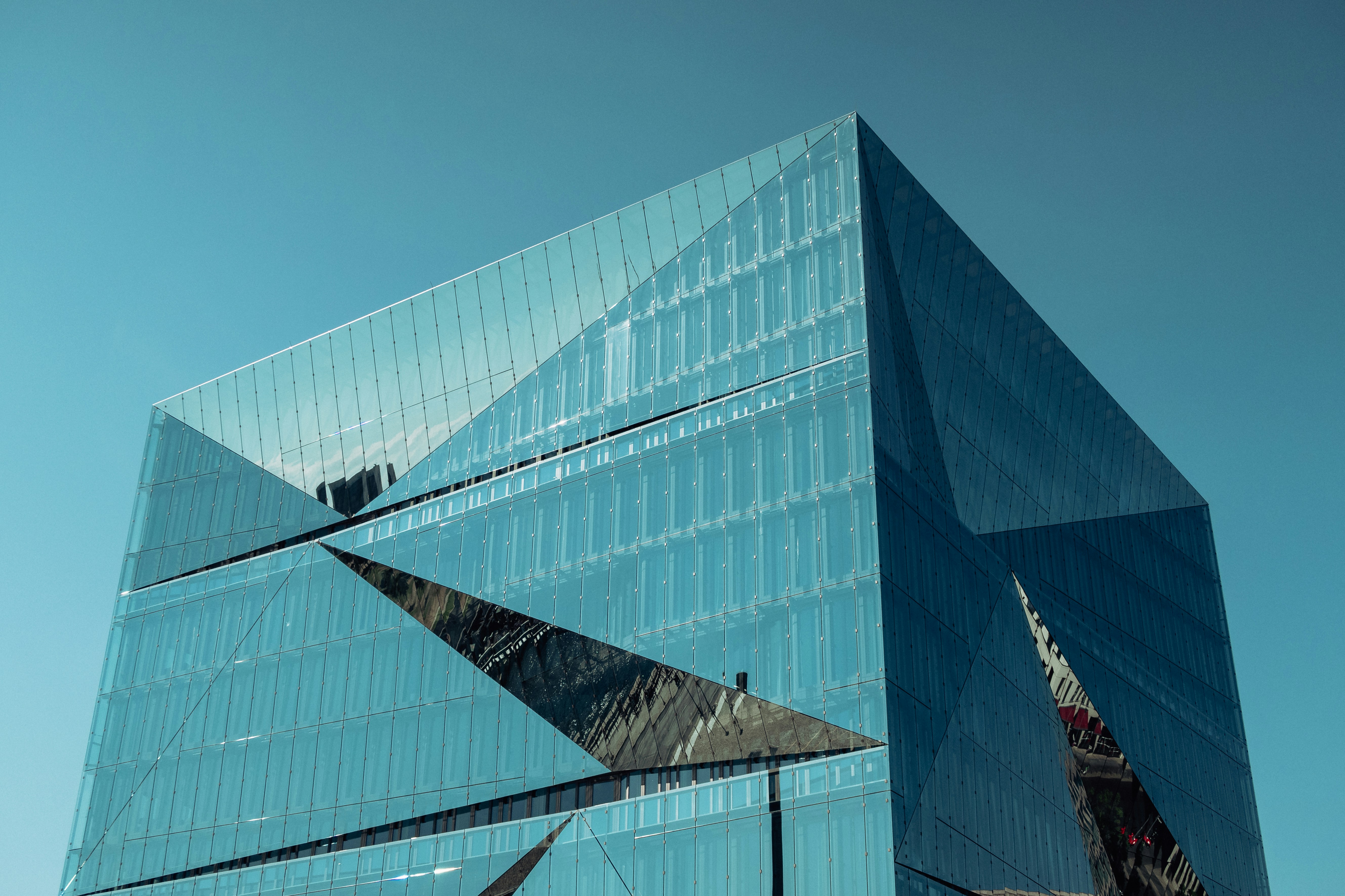 Cube Berlin | a very tall glass building with a sky background