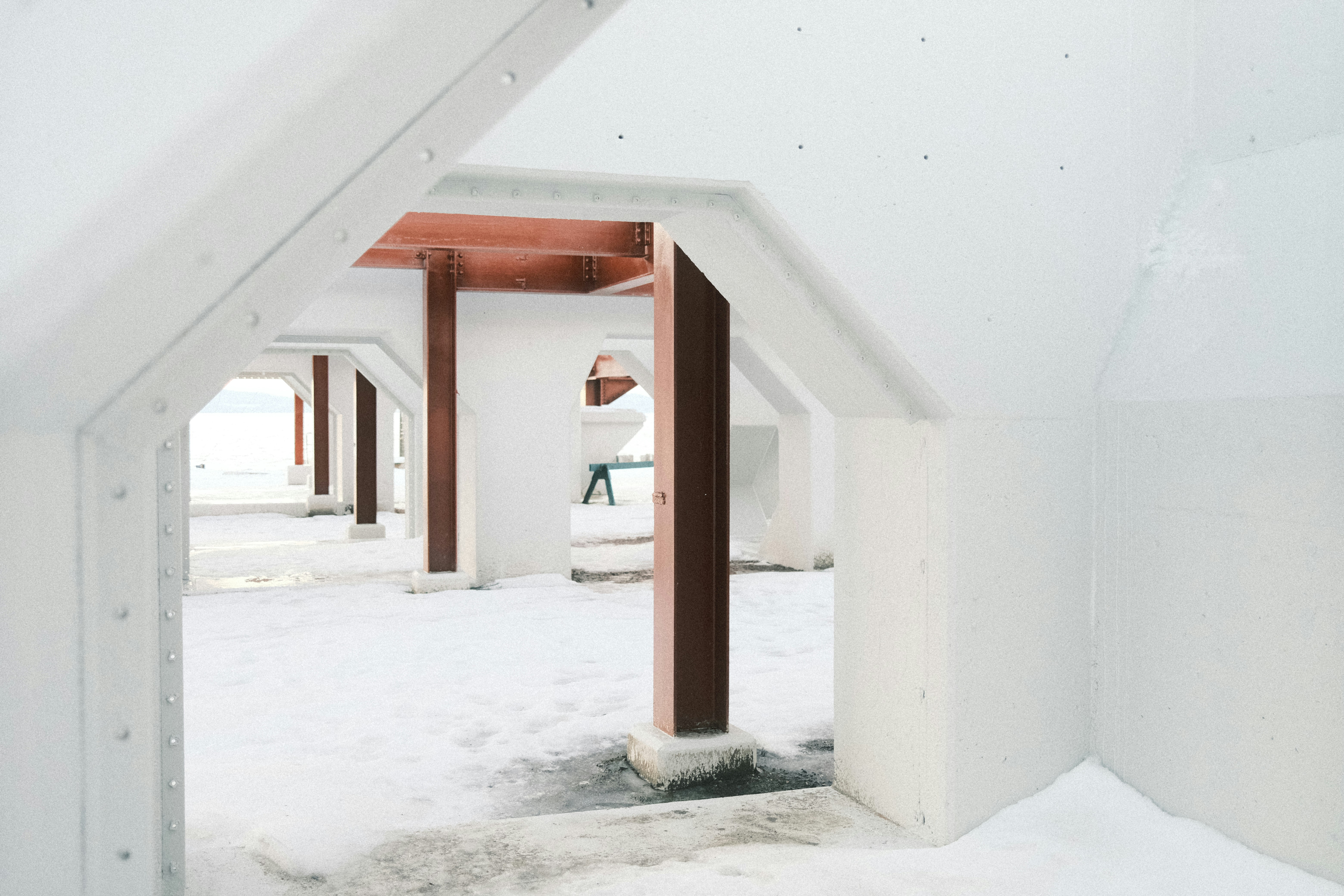 a white building with a person walking in the distance