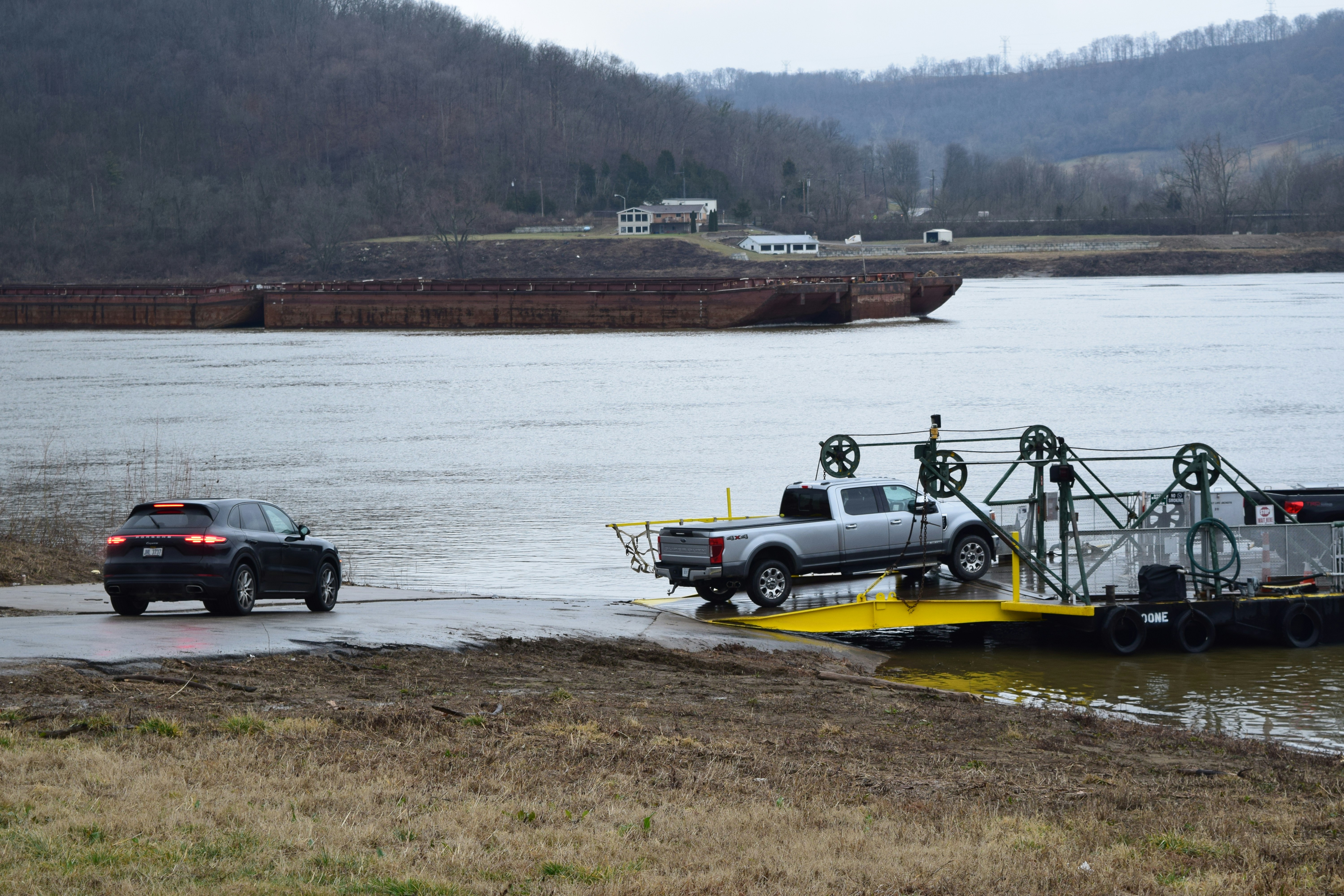 A tow truck towing a car across a body of water photo – Free Anderson ...