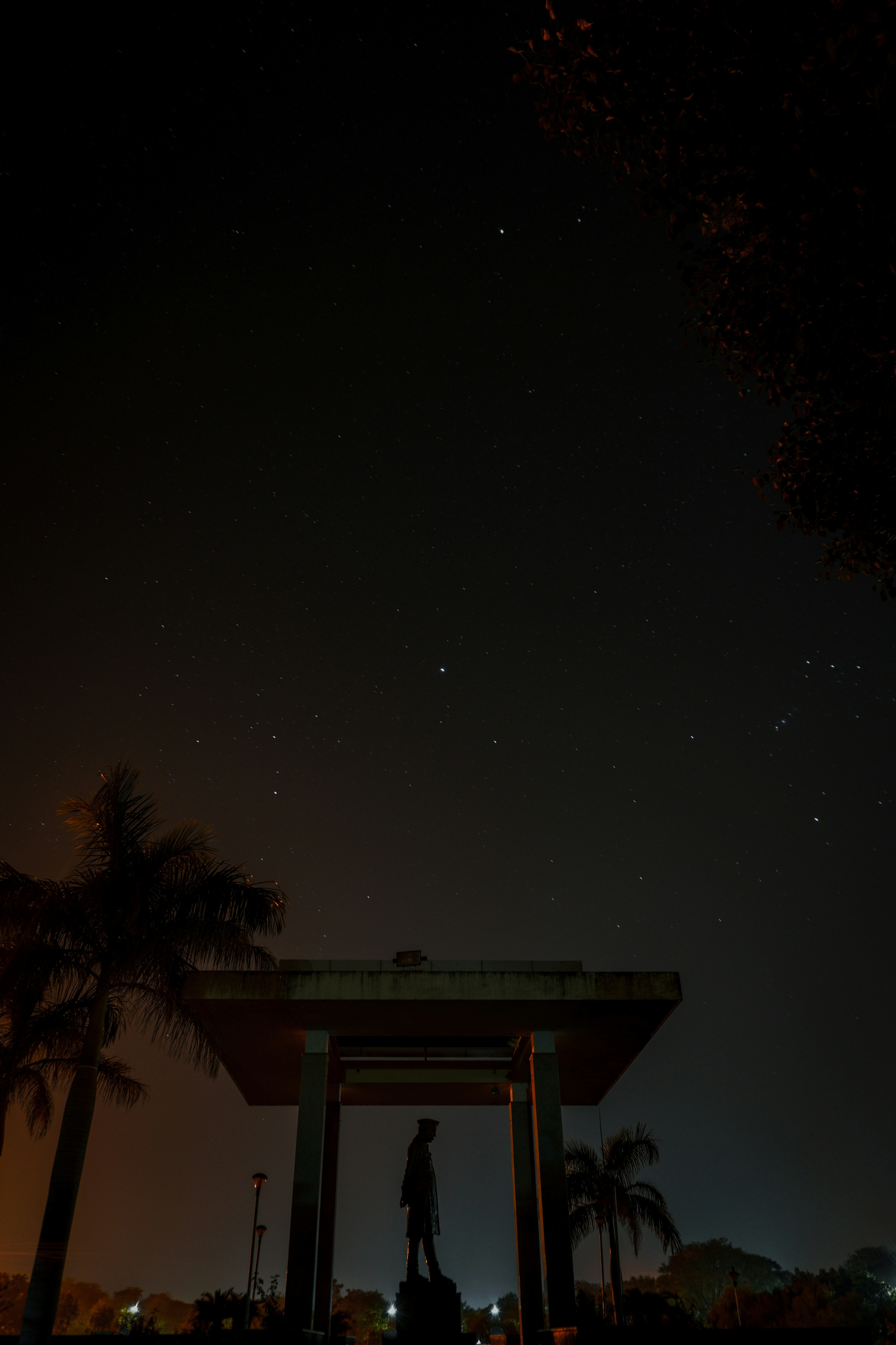 a person standing in front of a building under a night sky