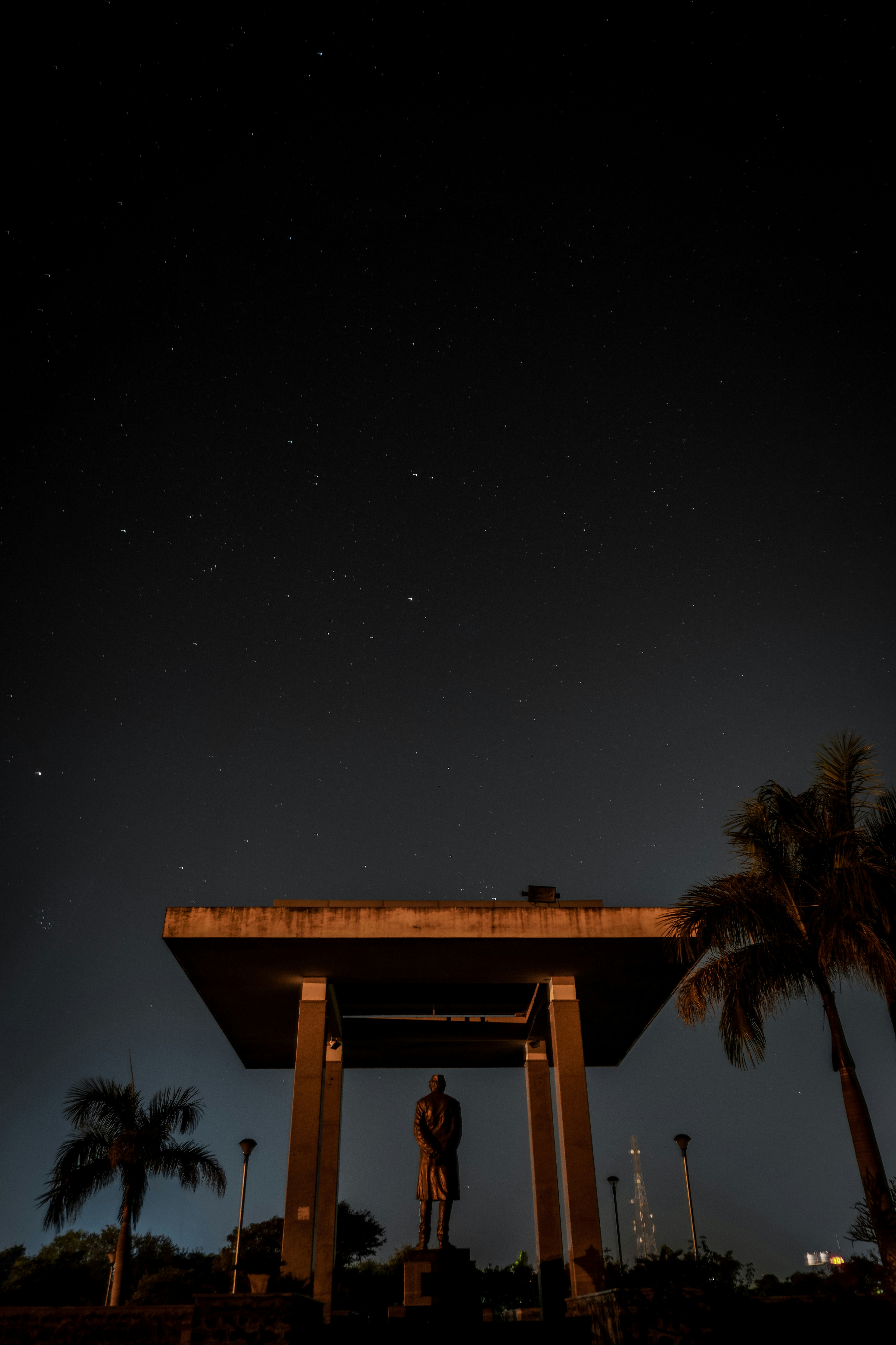 A night sky with stars above a building and palm trees photo – Free ...