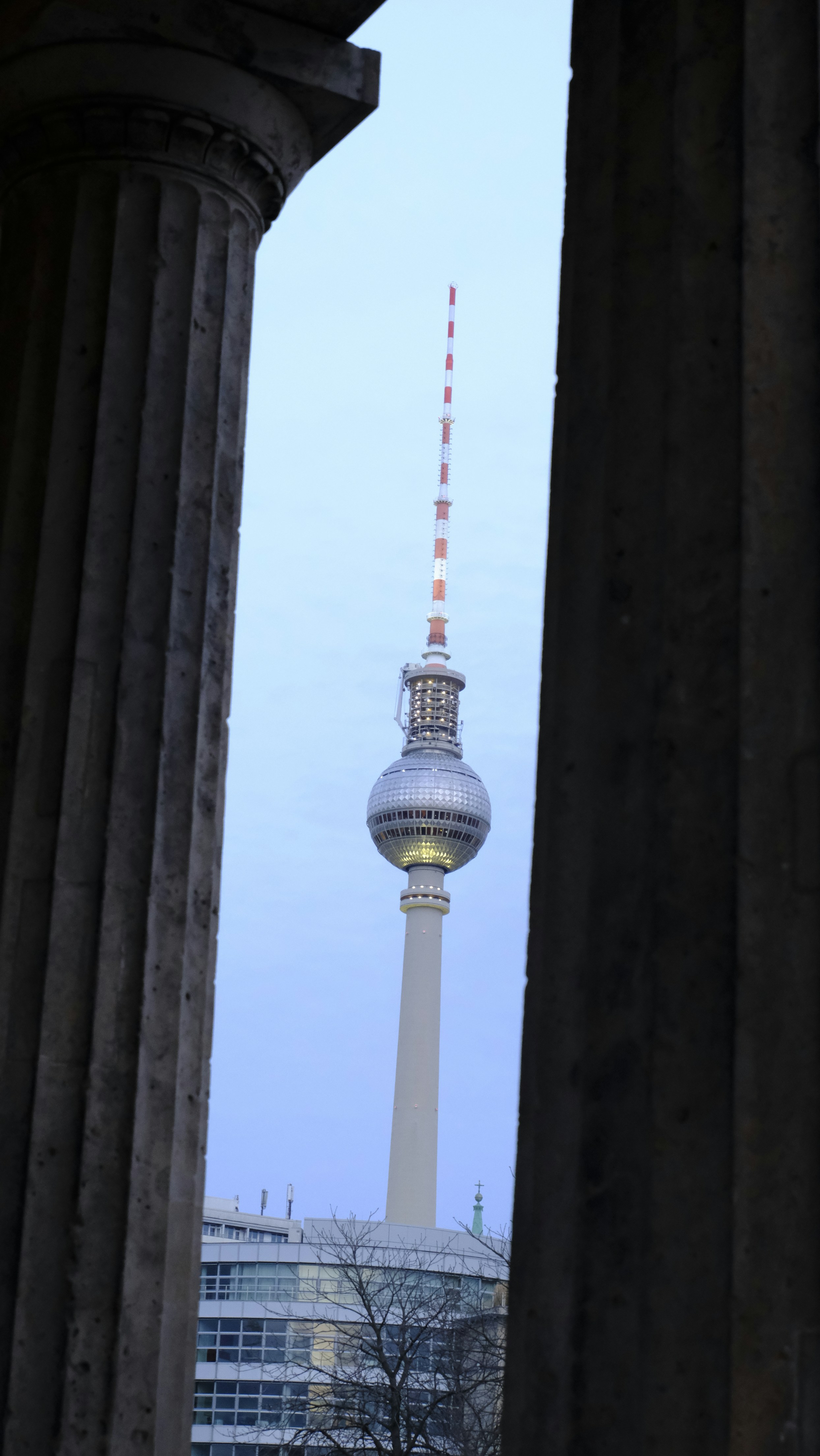 Framed Fernsehturm: Berlin's TV Tower Rising Between Classical Columns