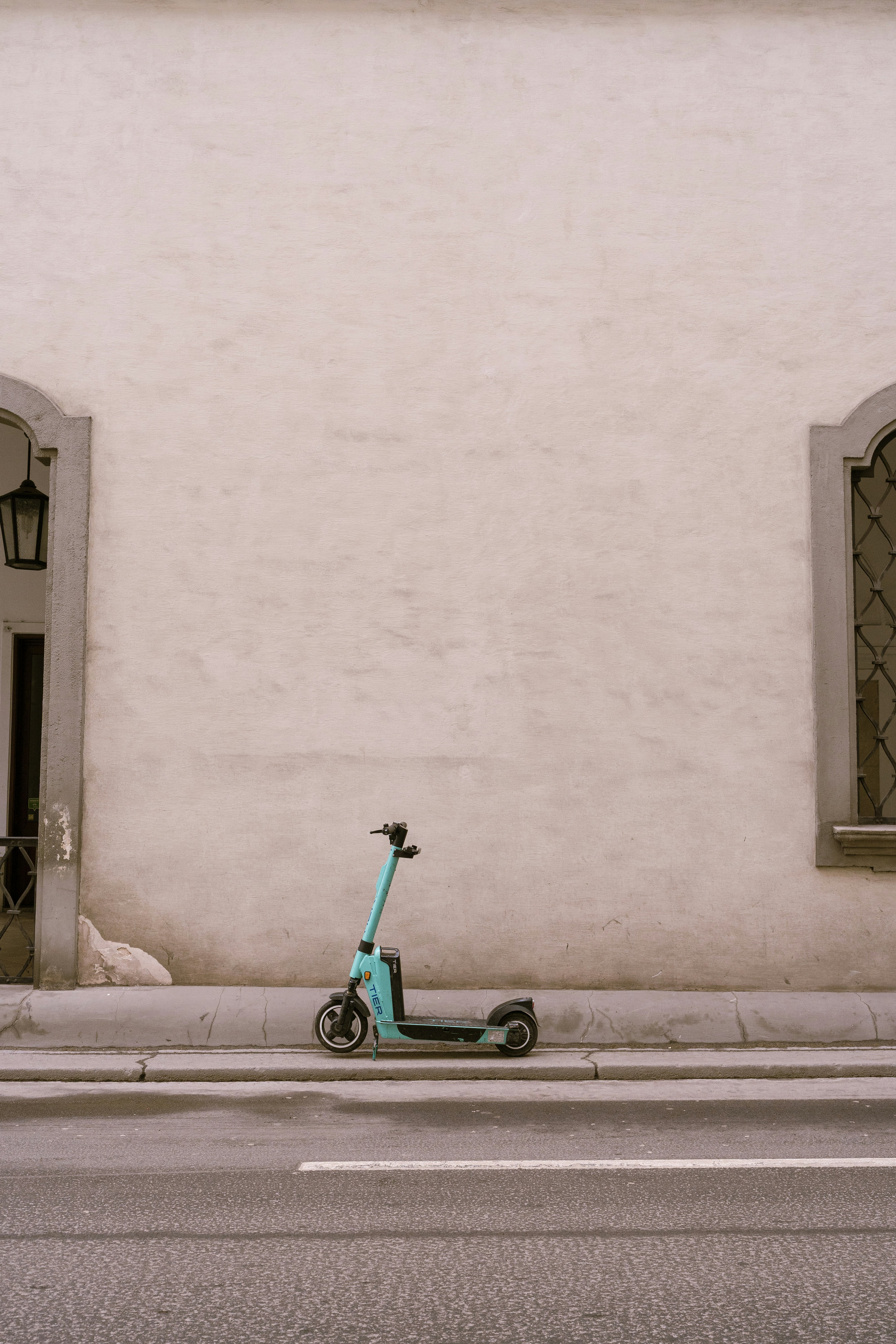 Electric scooter against wall in Vienna | a scooter parked on the side of the road