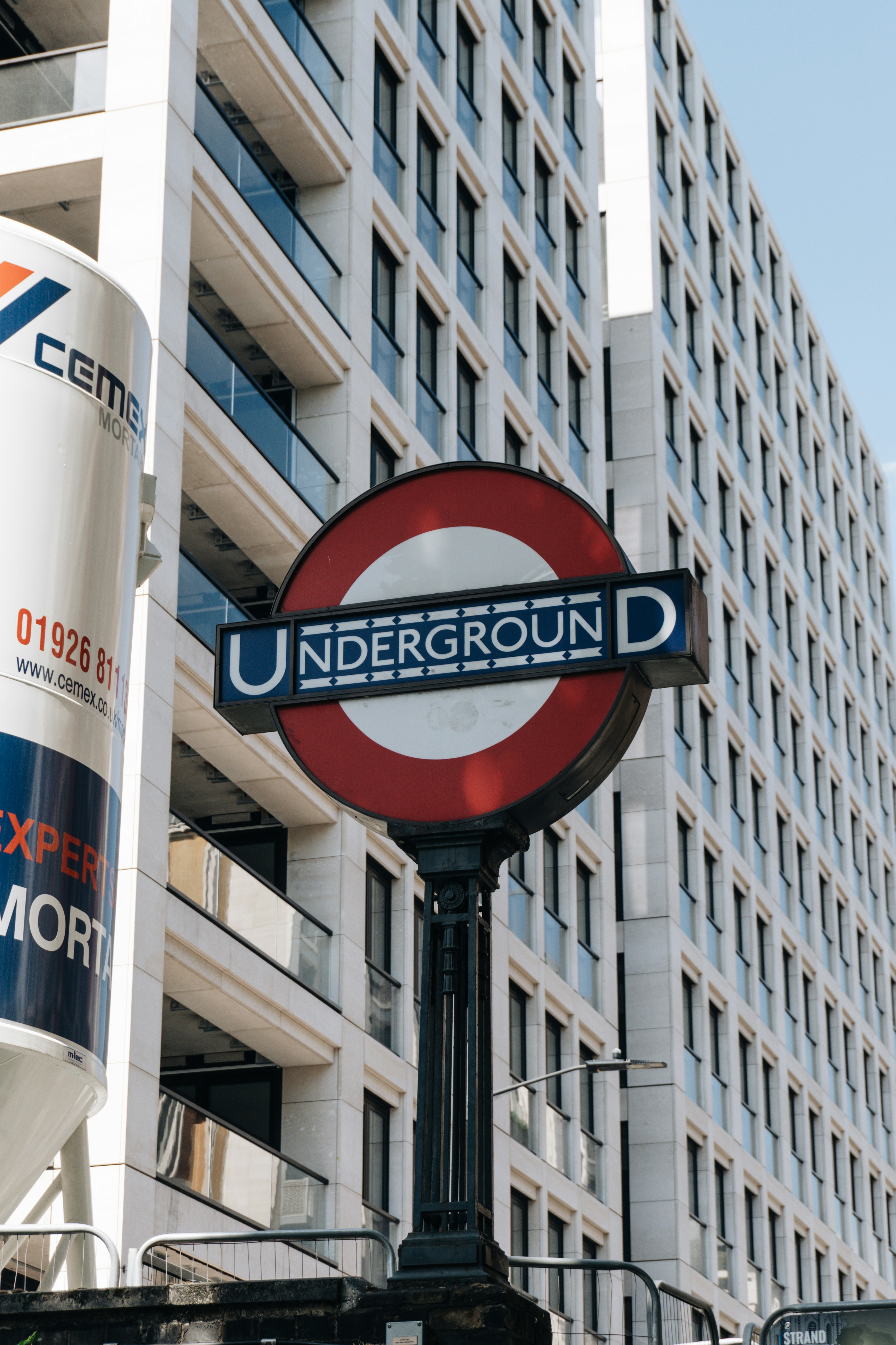 Roundel in the Urban Canopy: The Underground Sign Amid Modern Cityscape