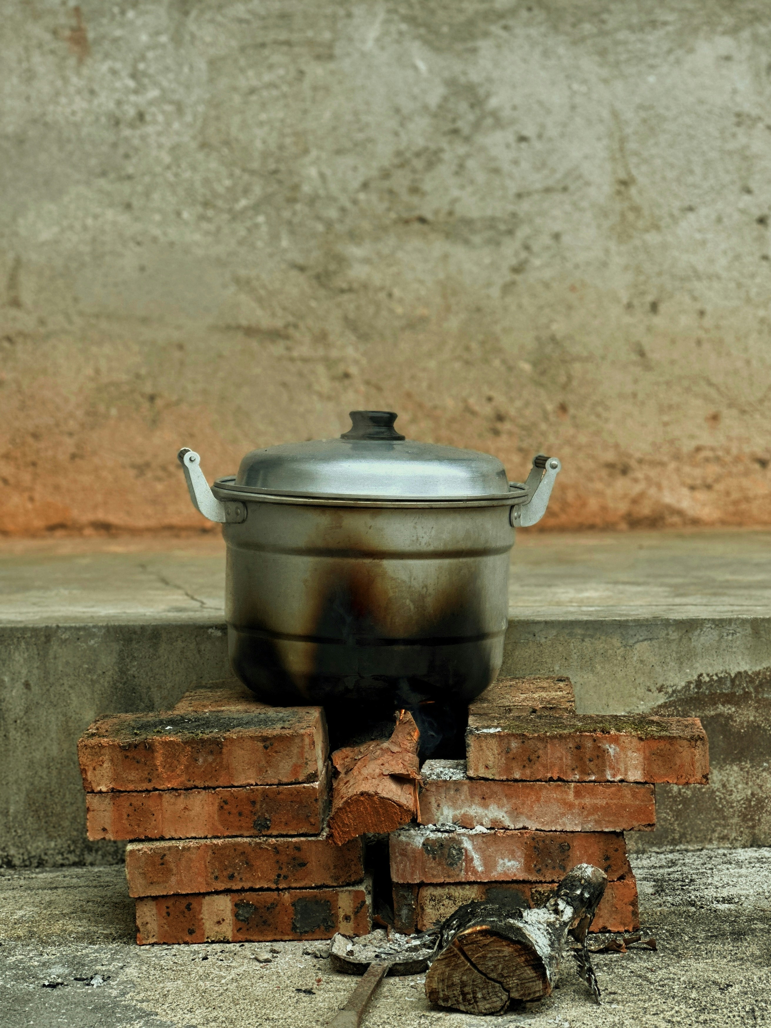 Center Stage on Brick and Iron: A Pot Quietly Resting Above the Hearth