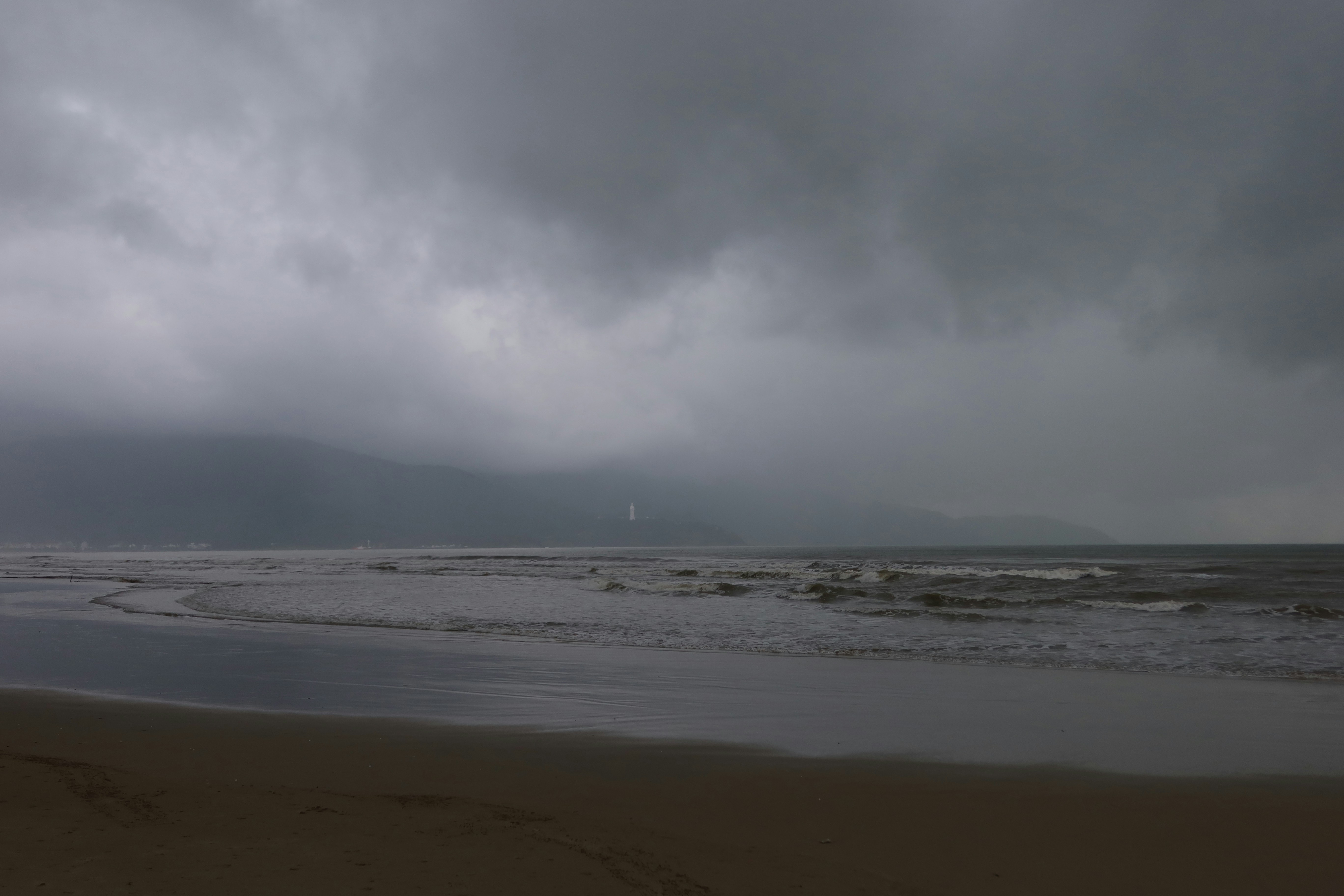 Lone Beacon on a Storm-Driven Shore: Seascape Under Menacing Clouds