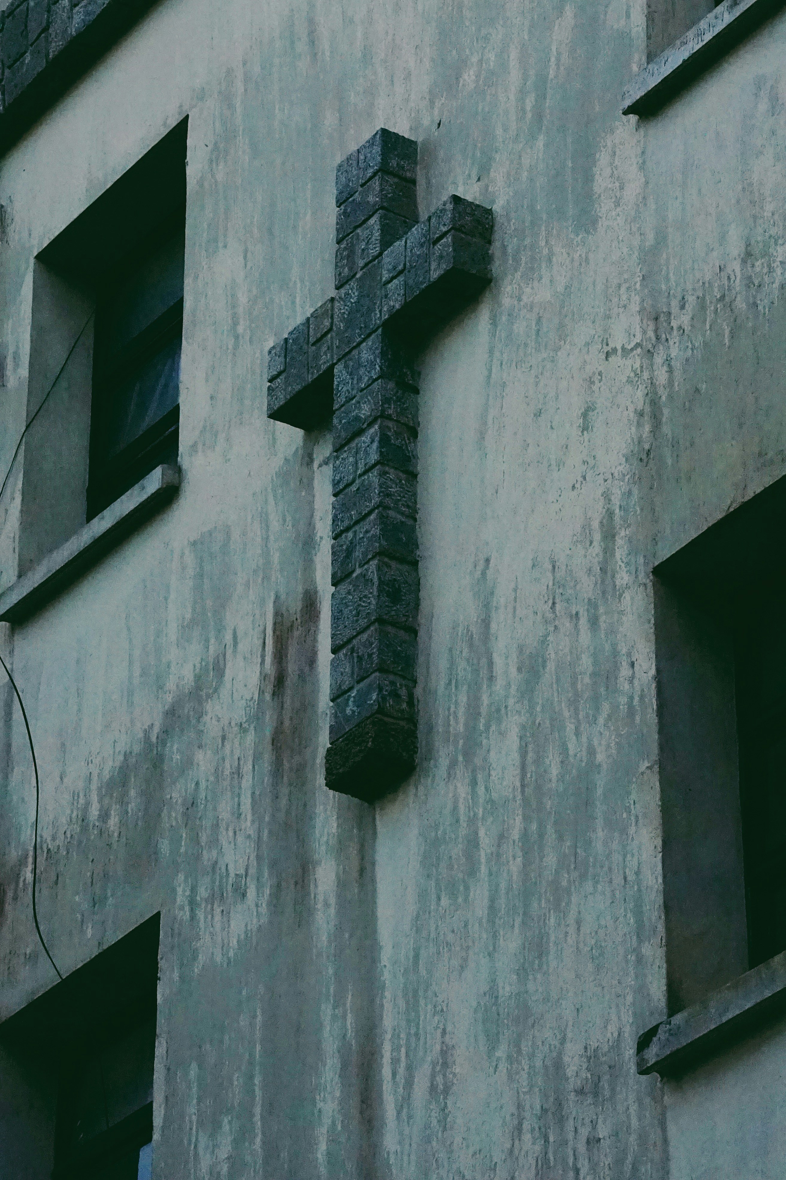 Brick Cross on a Weathered Facade: A Quiet Geometry