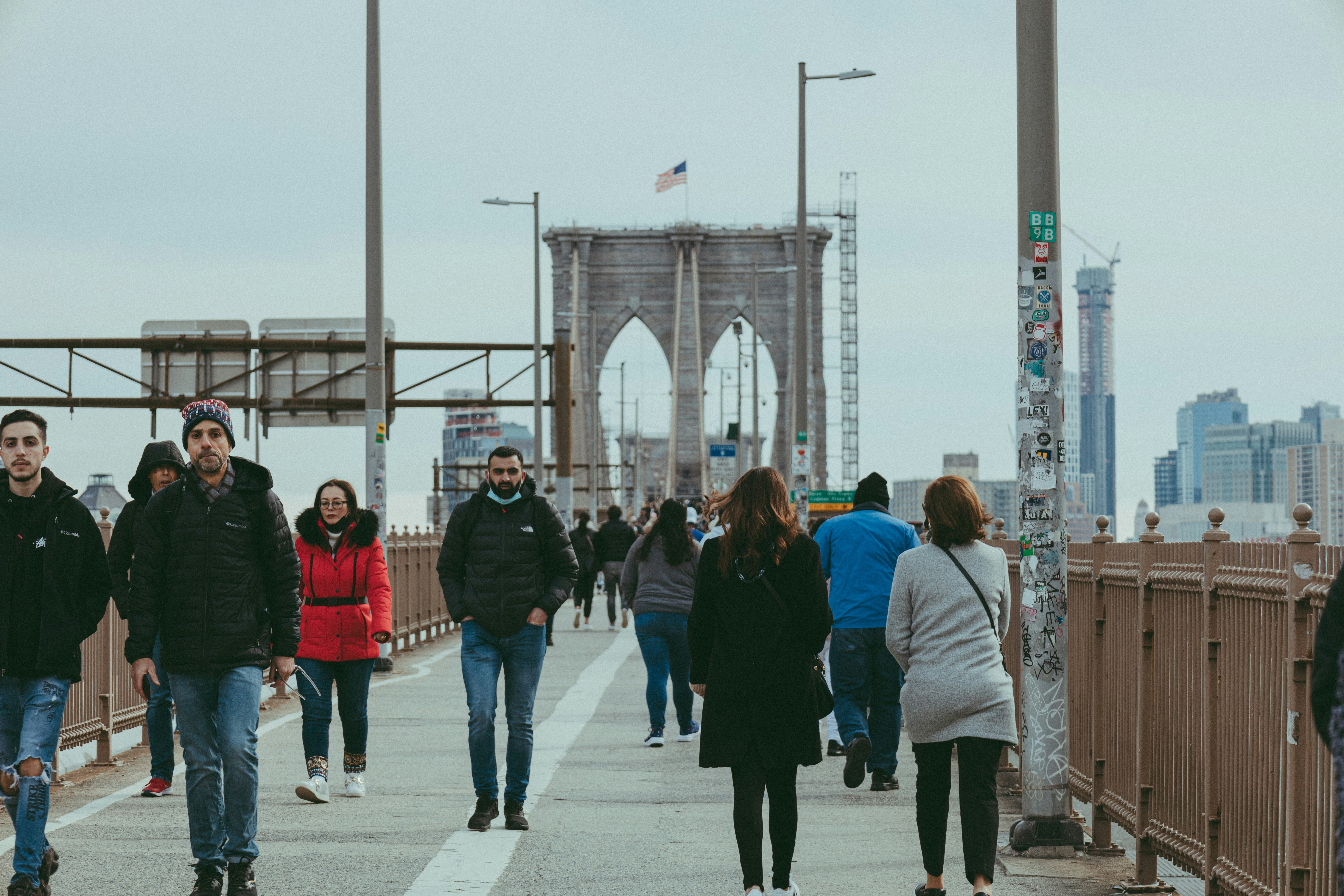 A group of people walking across a bridge photo – Free New york Image ...