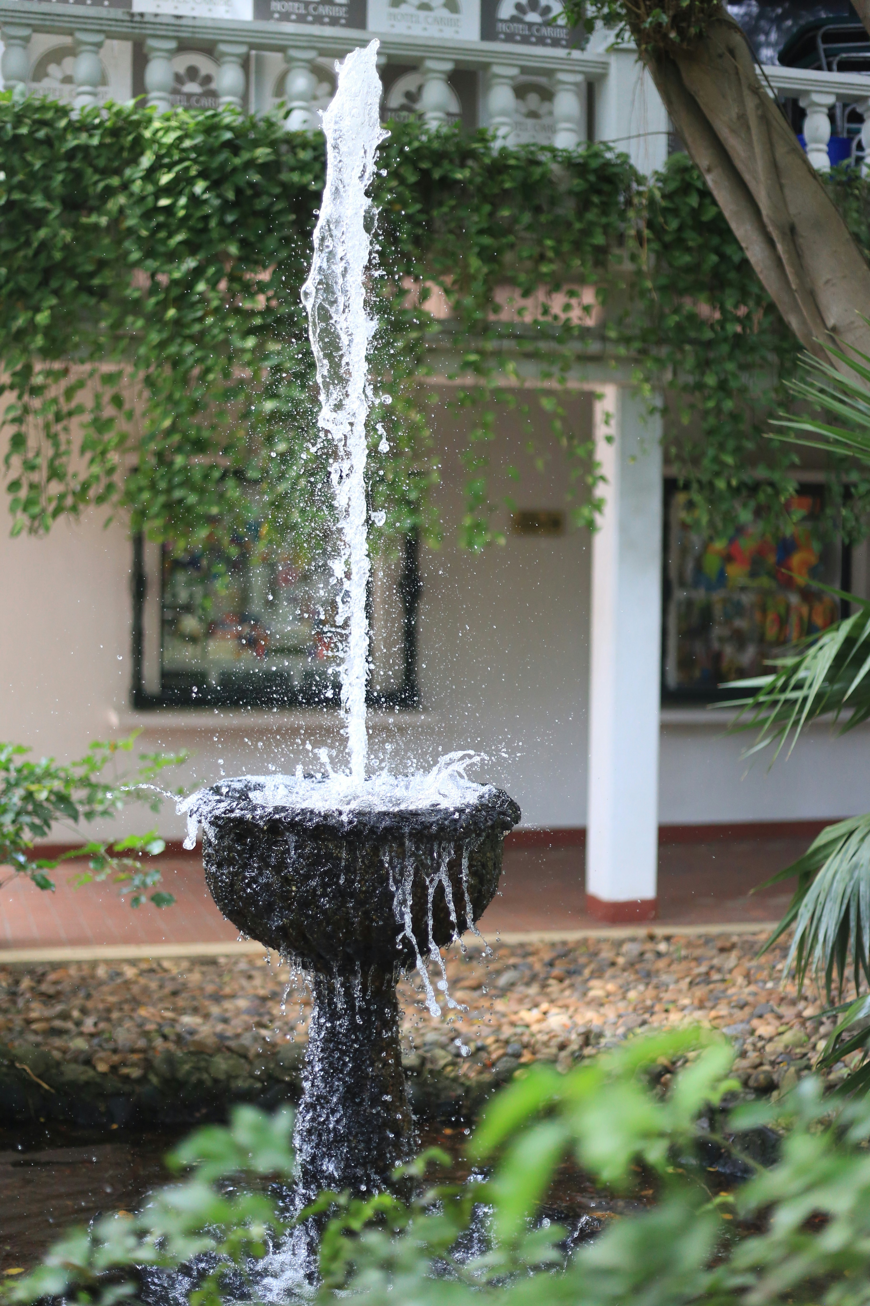 A water fountain in front of a building photo – Free Fountain Image on ...