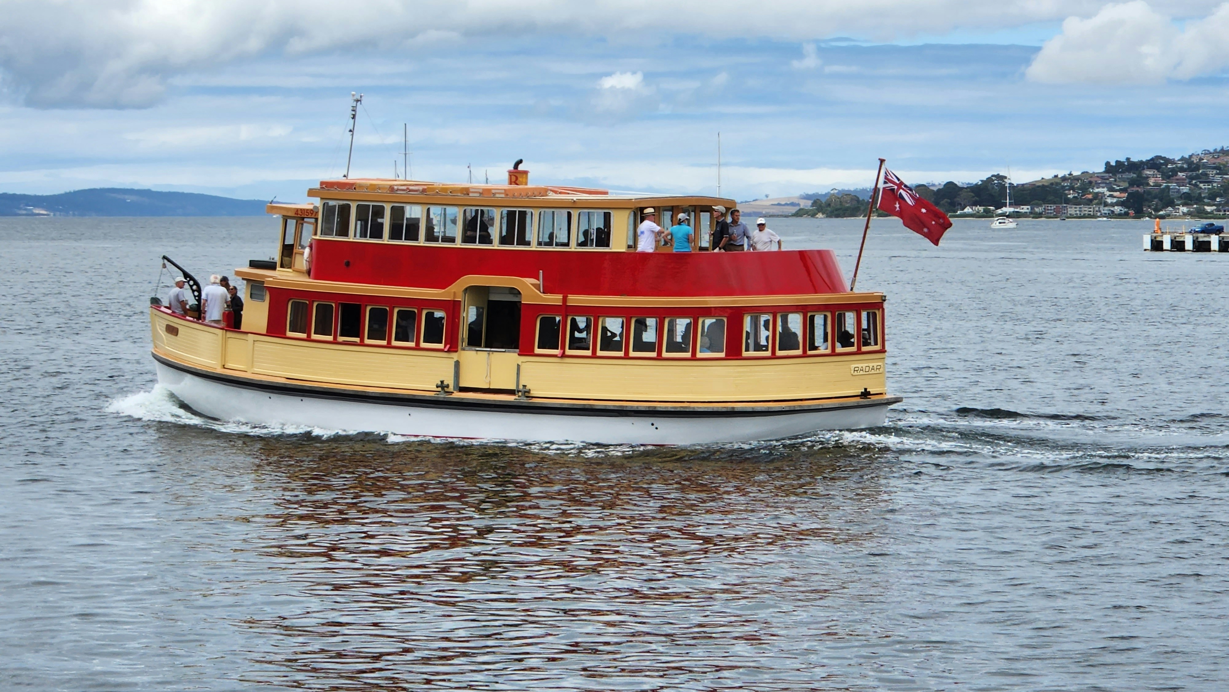 Sunlit Harbor Steamer: A Classic Vessel Skimming Calm Waters