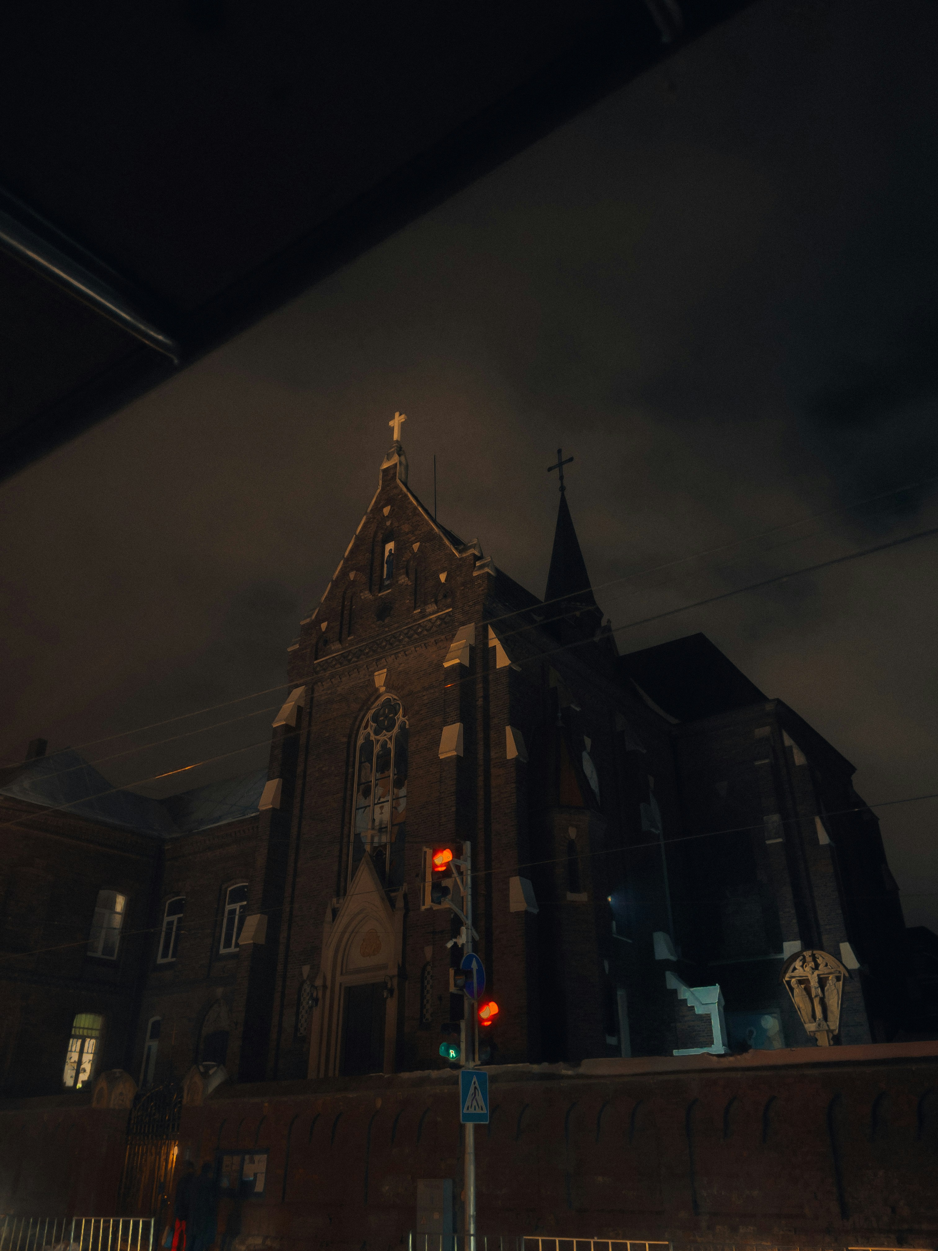 Nocturnal Gothic: Cross-Topped Brick Church Bathed in Streetlight