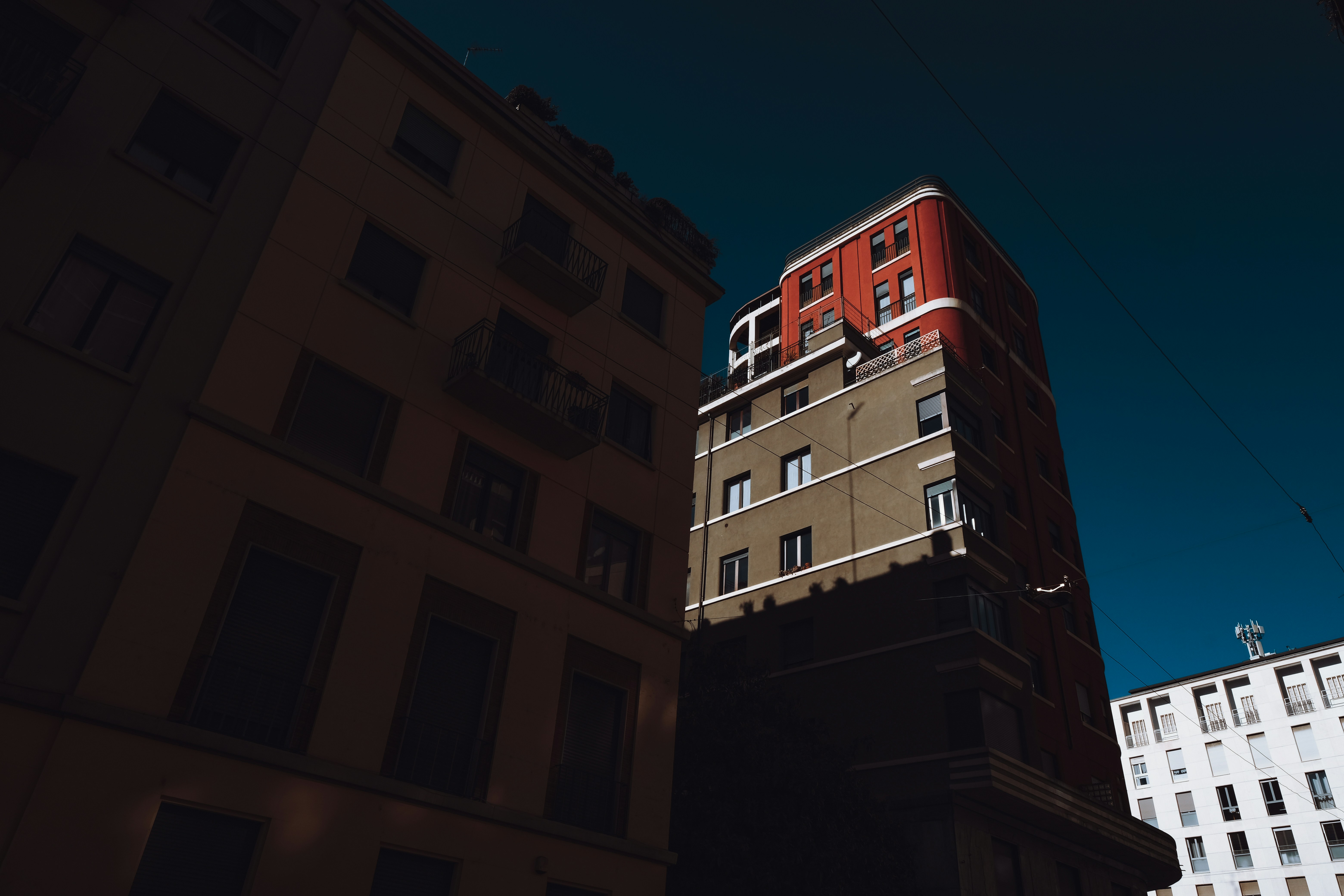 A tall building with a red sign on top of it photo – Free City Image on ...